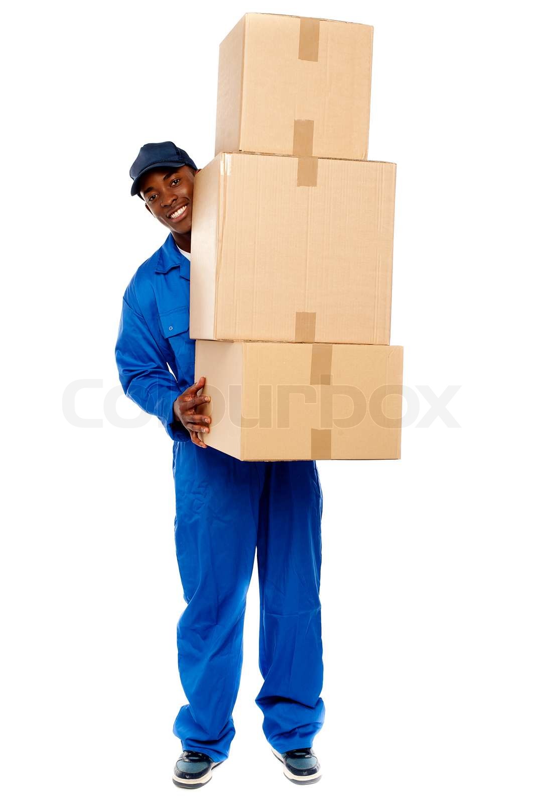 Delivery boy carrying heavy boxes | Stock image | Colourbox