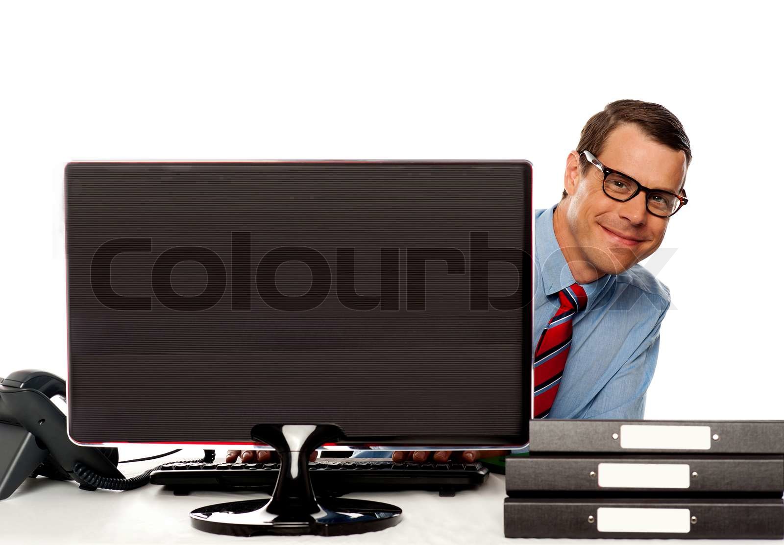 Man peeping from behind computer screen and enjoying at work Sitting in ...