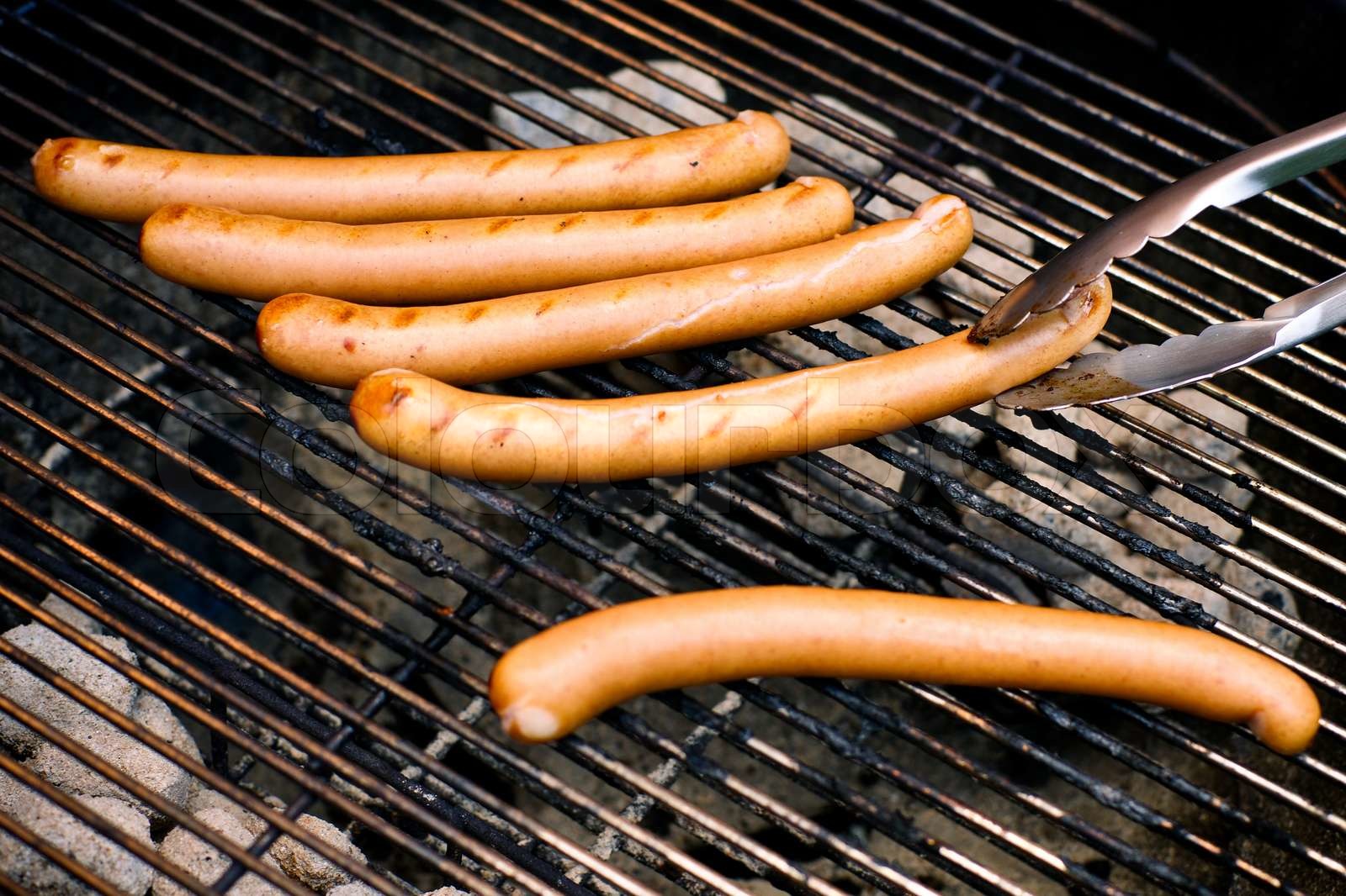 Wieners on a grill | Stock image | Colourbox
