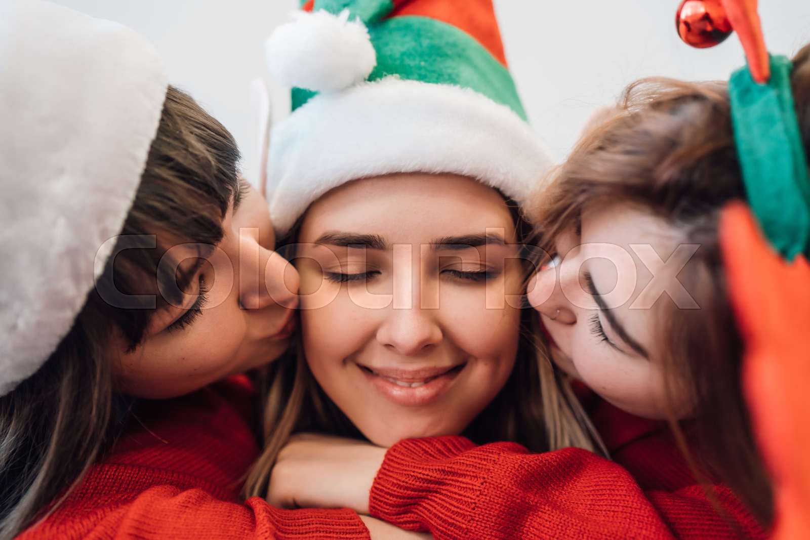 Portrait Of Three Women Friends Wearing Leisure Clothing Hugging