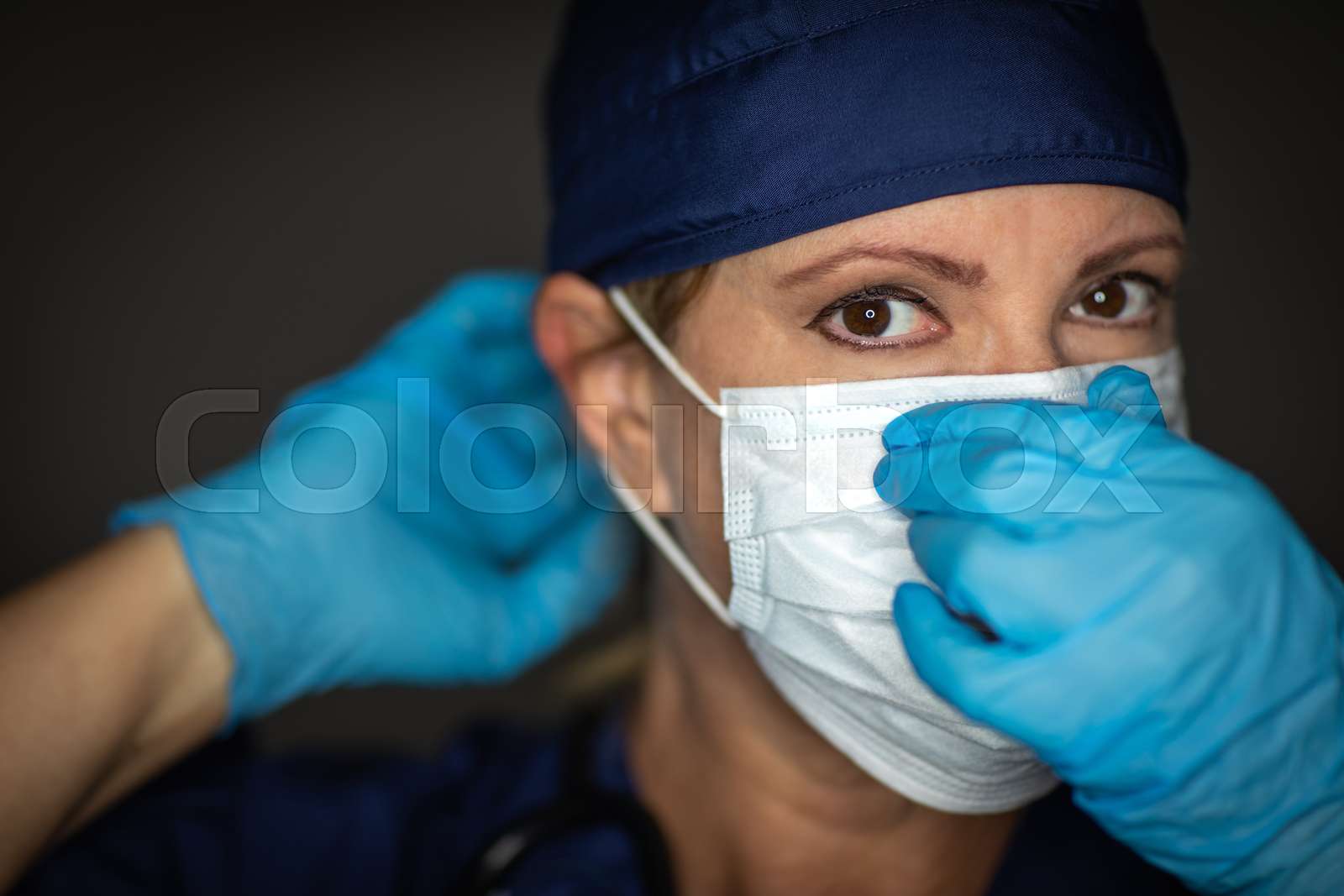 Female Doctor or Nurse Wearing Surgical Gloves Putting On Medical Face ...