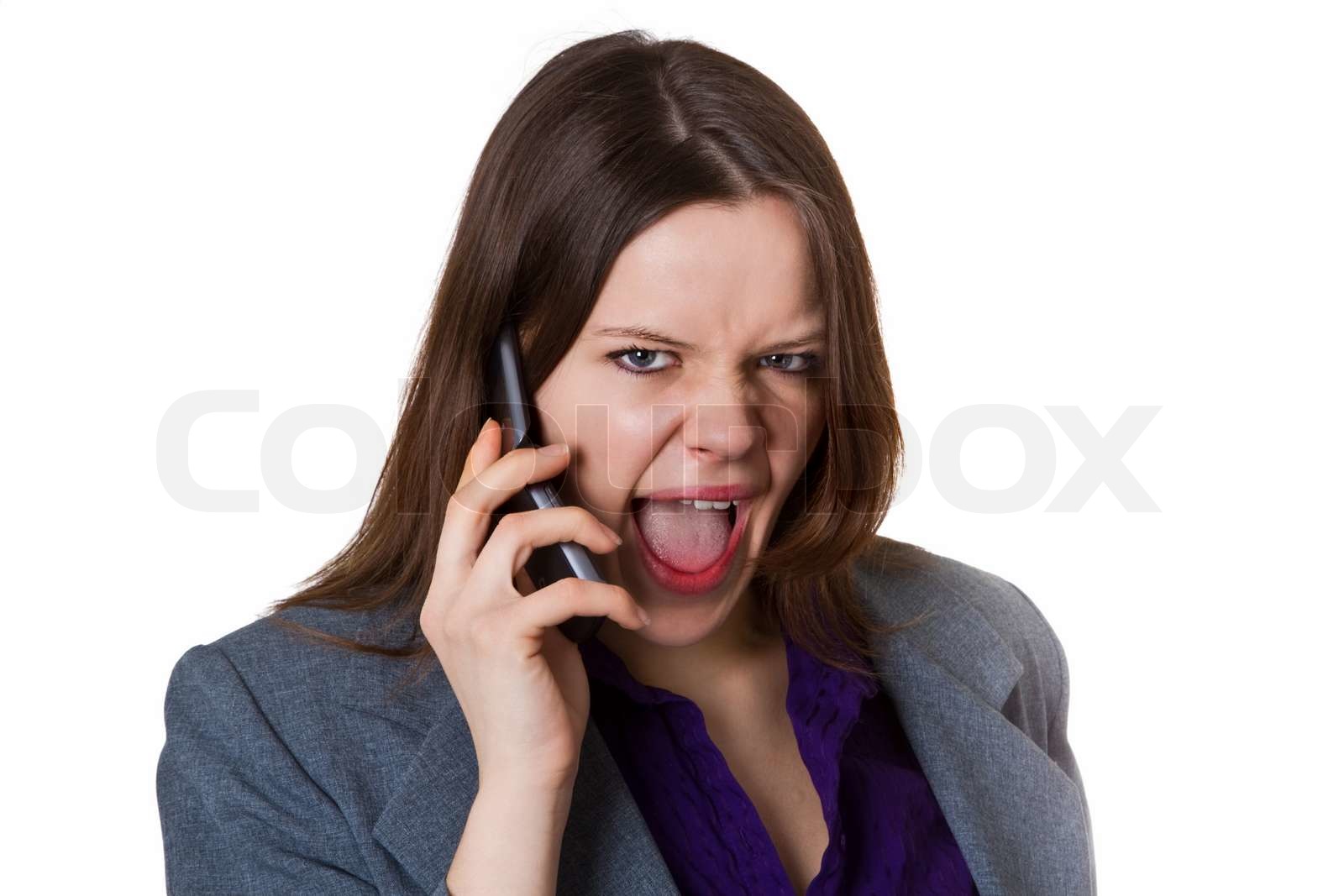 Businesswoman screaming into the phone | Stock image | Colourbox