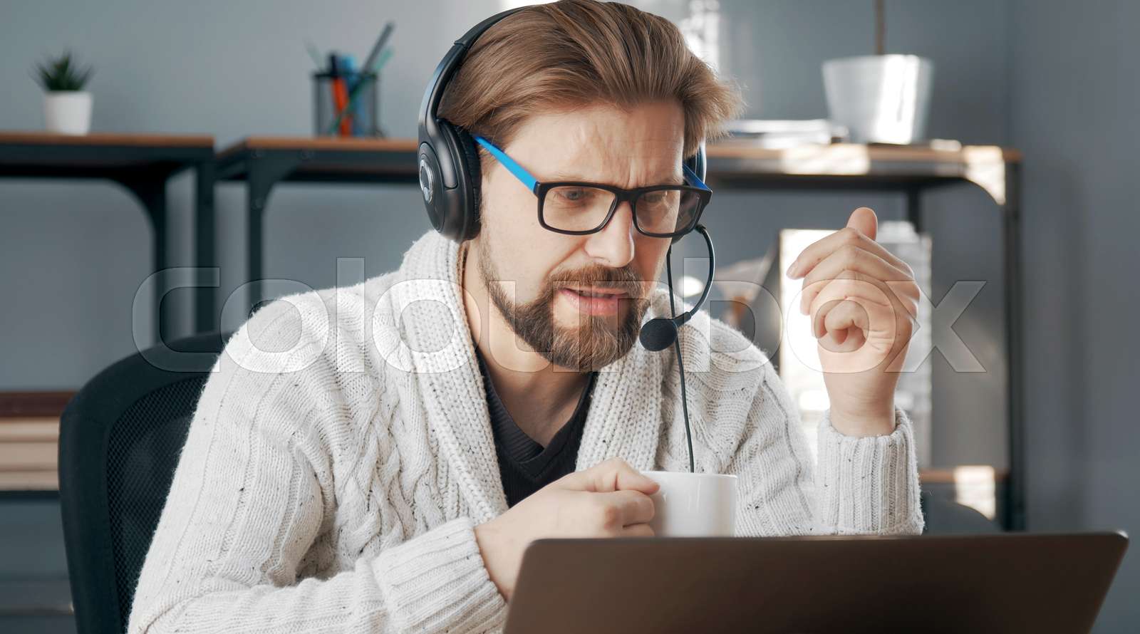 Male teleworking, headset on | Stock image | Colourbox