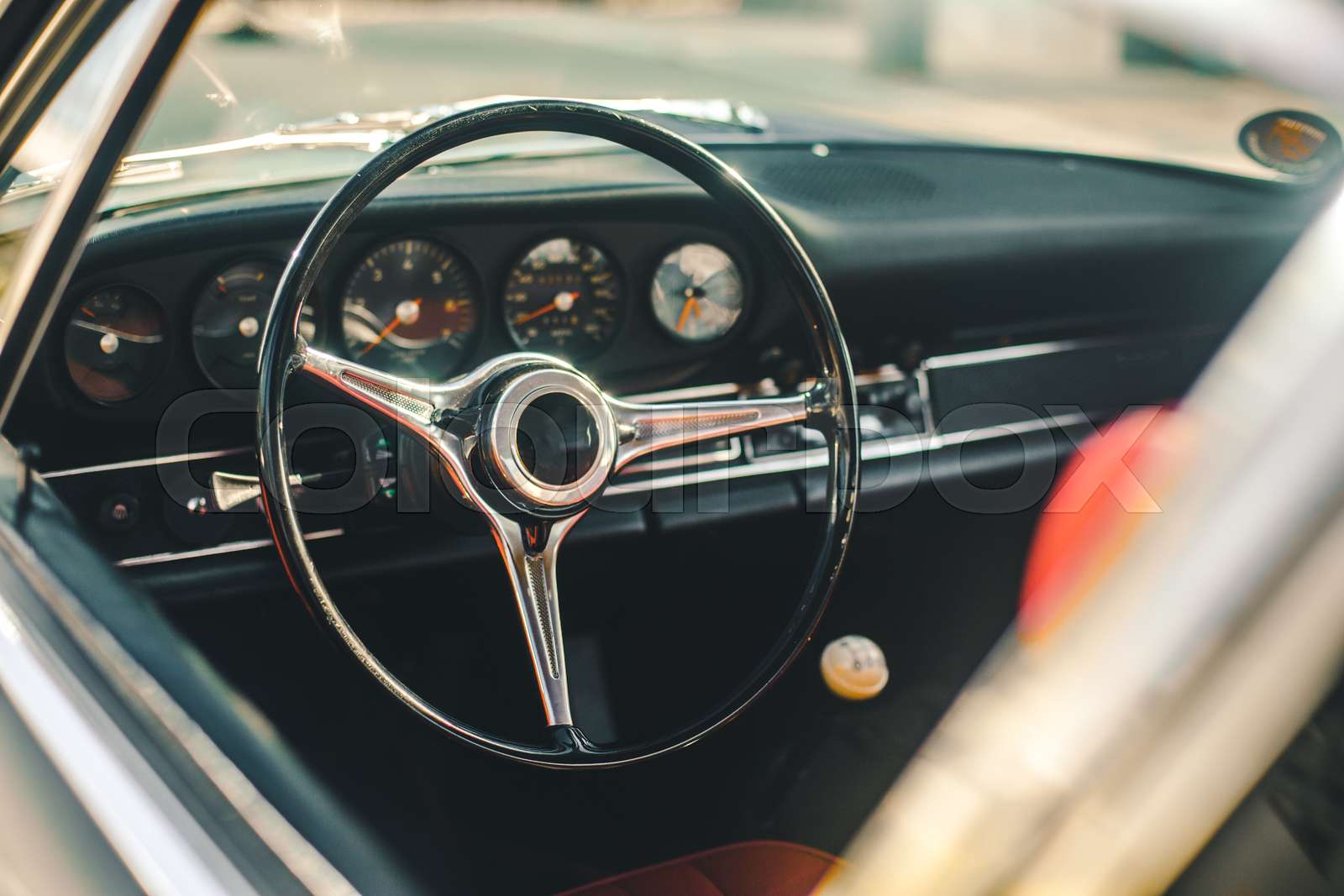 Control wheel and speedometer system of a retro car, view through ...