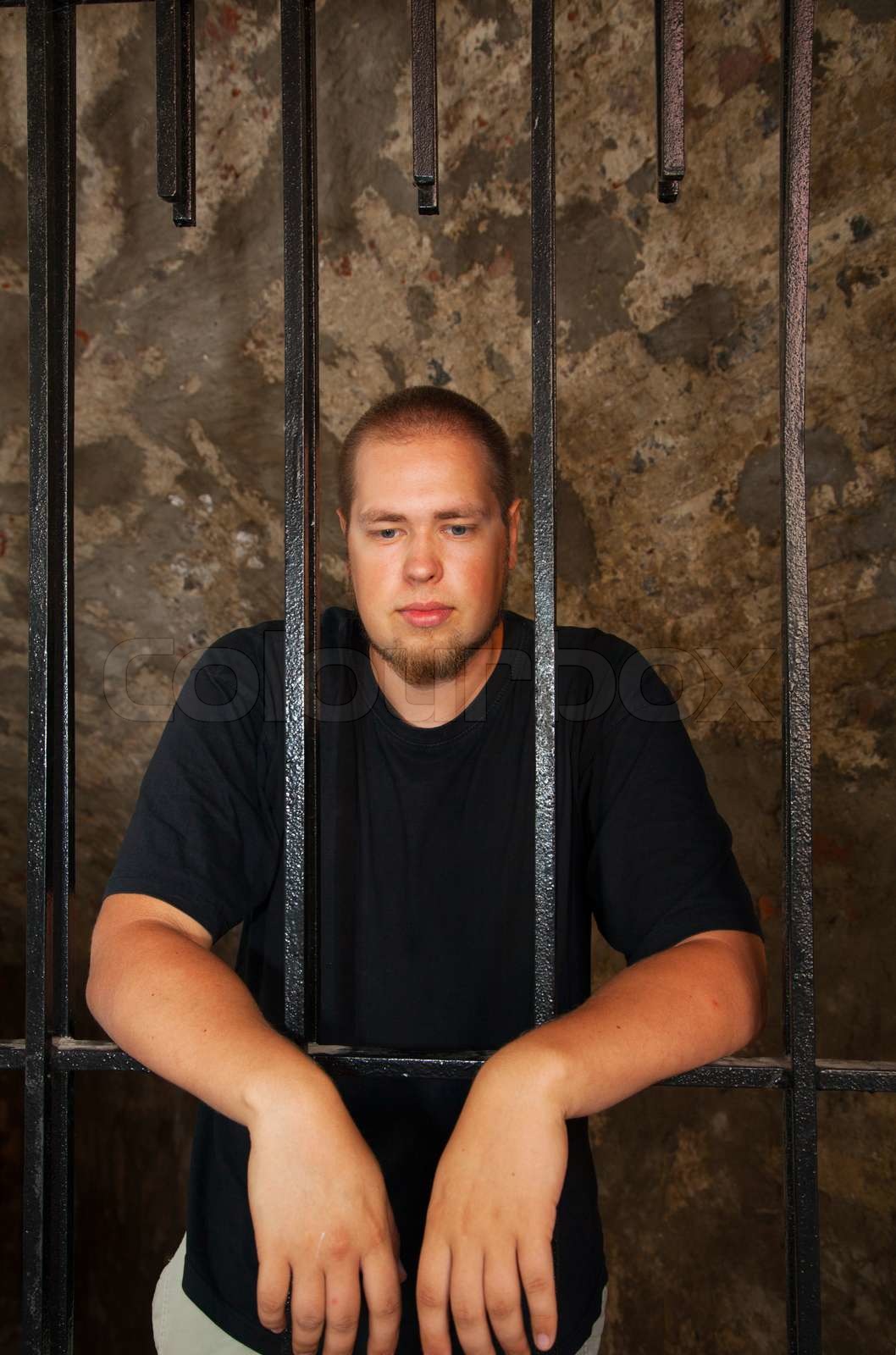 Young man behind the bars | Stock image | Colourbox