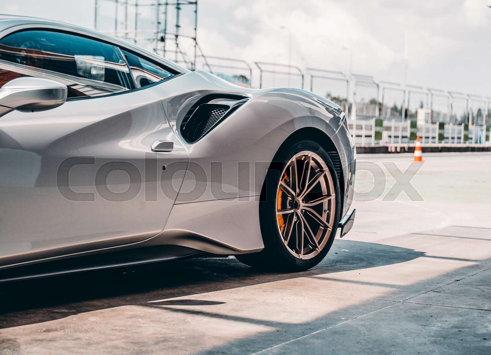 Silver racing car getting ready for a autoshow in the stadium | Stock ...