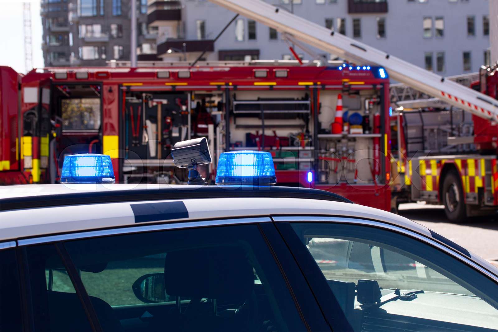 Police car with flashing lights in front of a fire truck. | Stock image ...