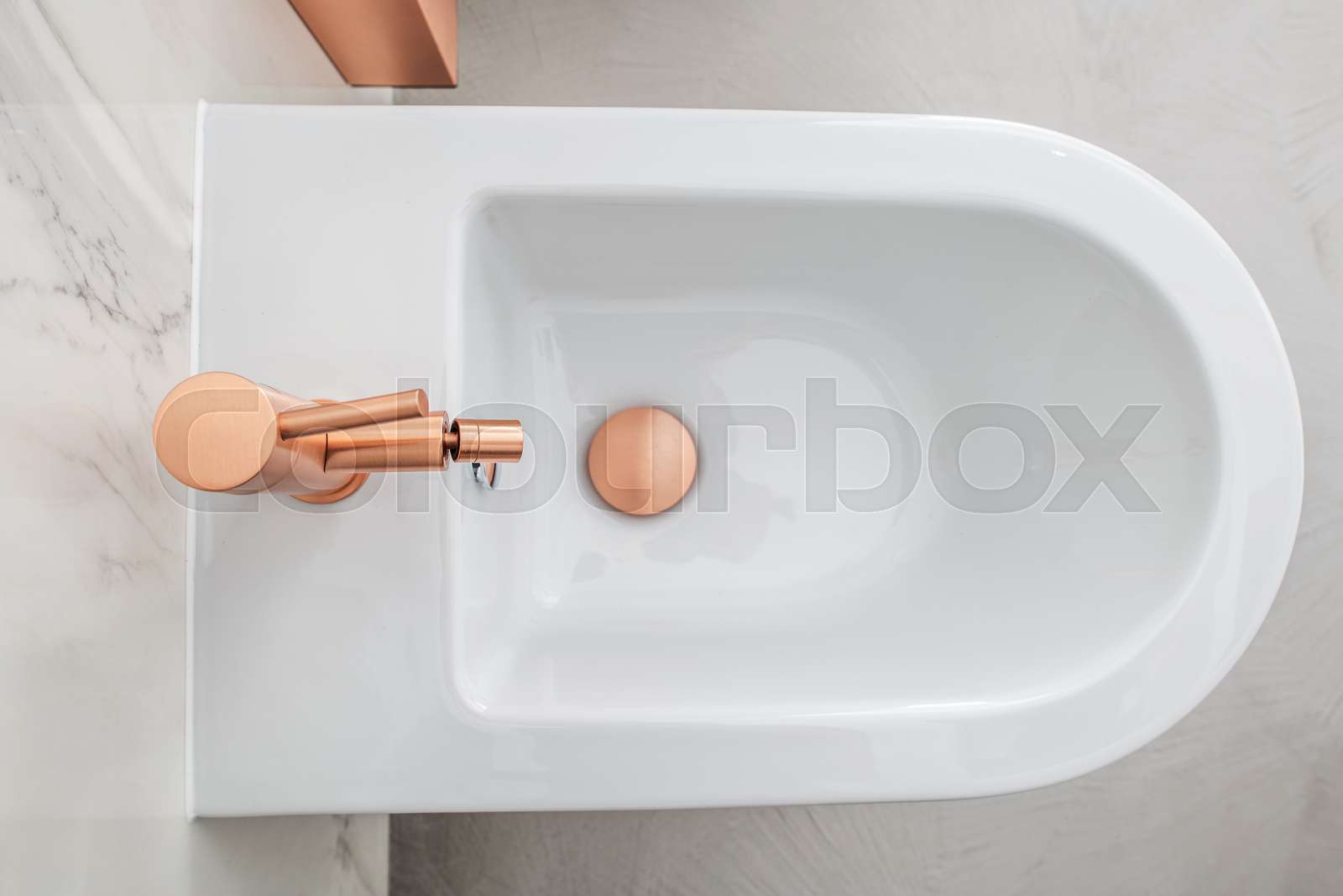 Posh White Bidet With Copper Fixture. | Stock image | Colourbox