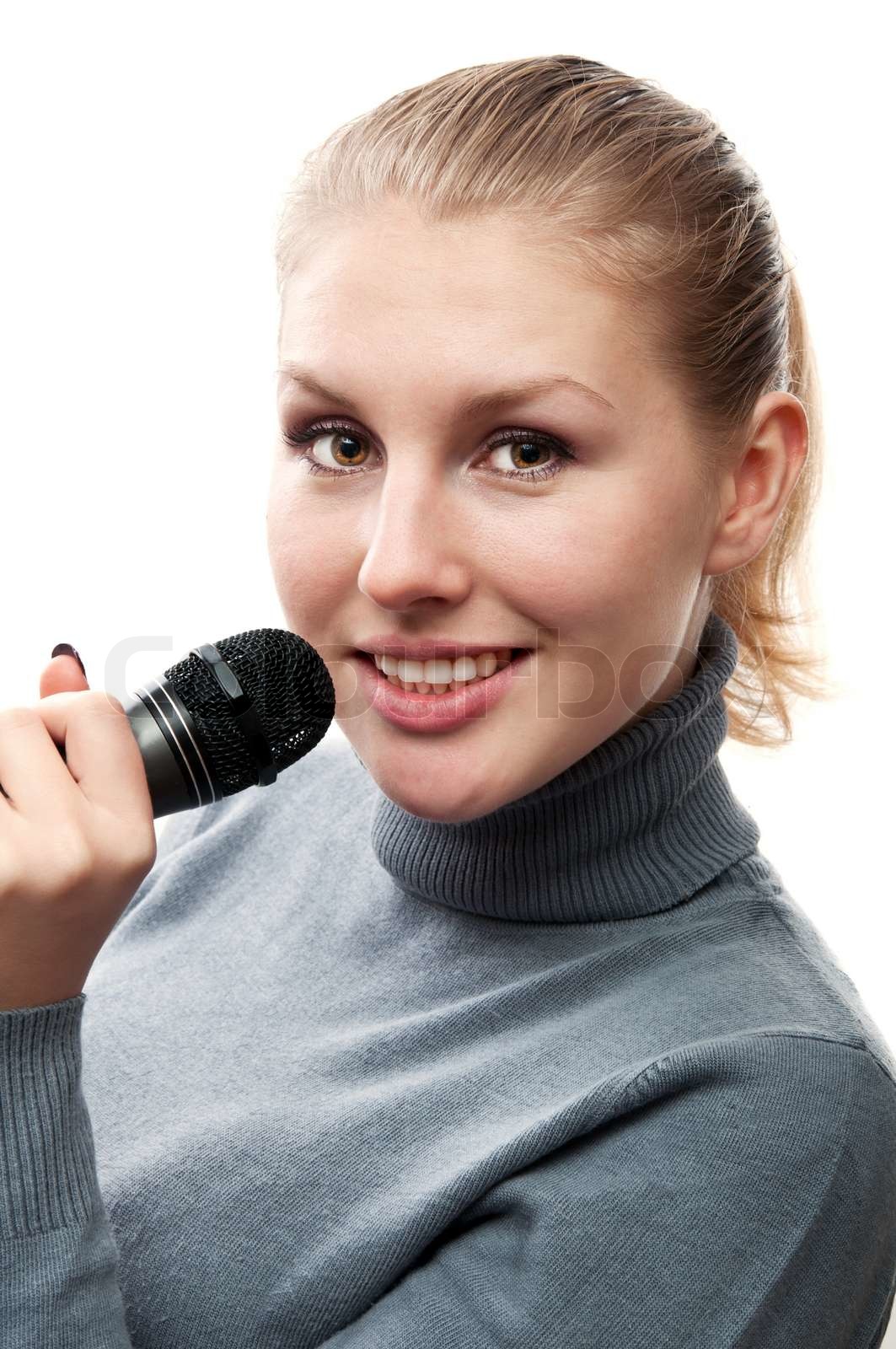 woman singing into a microphone | Stock image | Colourbox