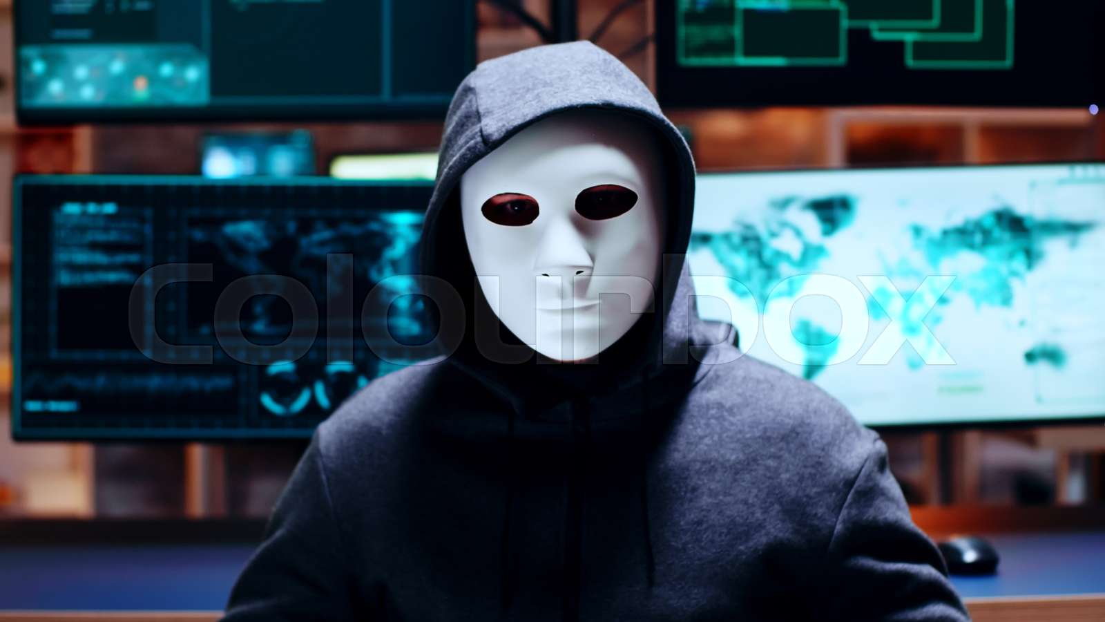 Zoom in shot cyber criminal wearing a white mask | Stock image | Colourbox