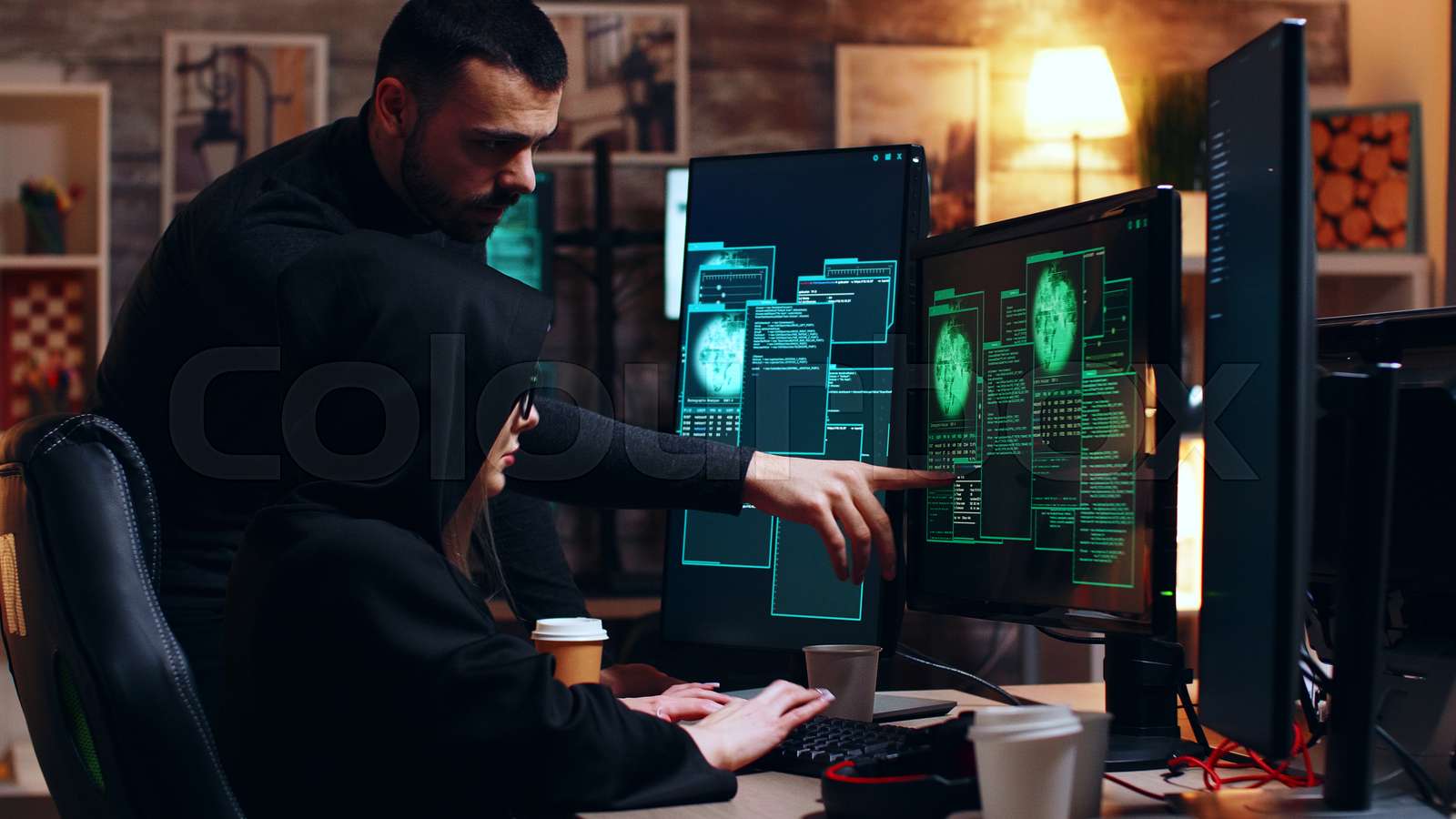 Hacker leader helping girl with her hacking | Stock image | Colourbox