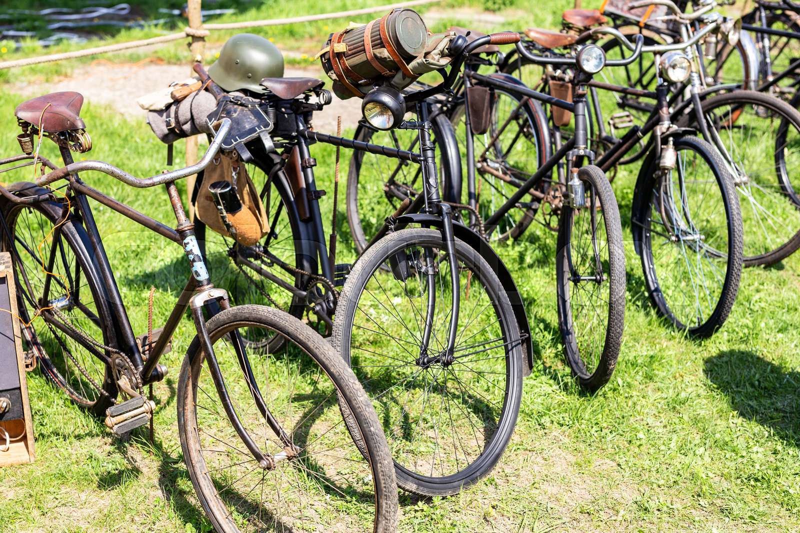 Many old rusty vintage retro german military bicyles stand in row on ...