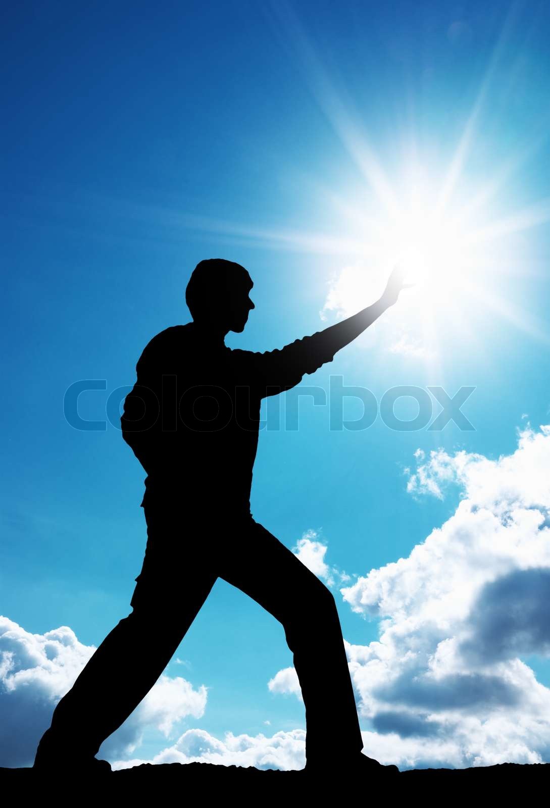 Man touch sun | Stock image | Colourbox