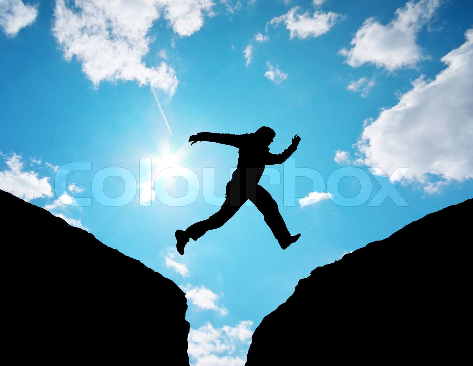 Man jump through the gap. | Stock image | Colourbox