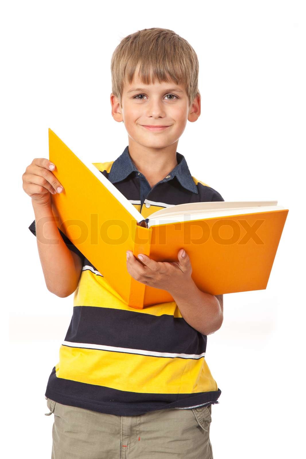 School boy is holding a book | Stock image | Colourbox