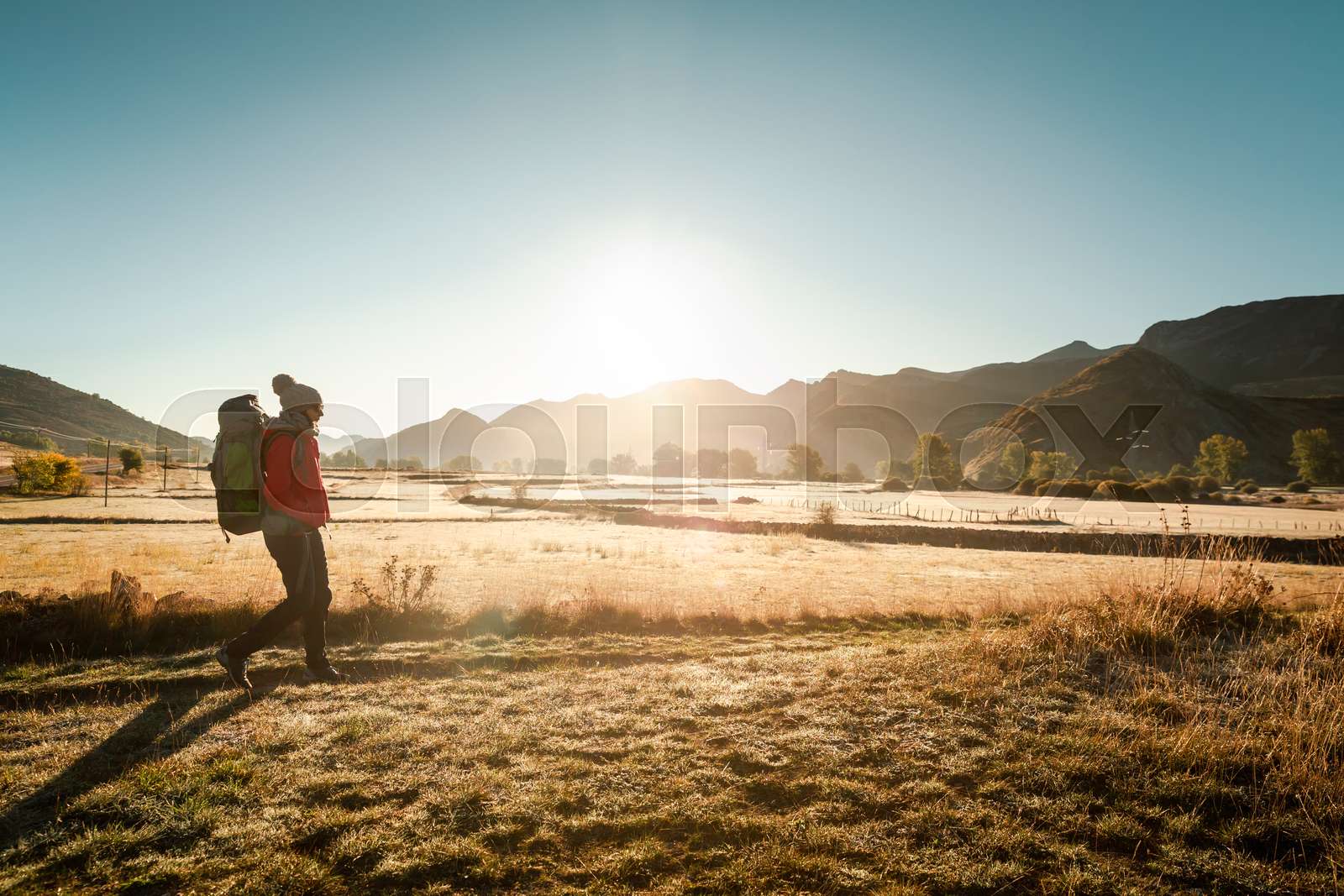 Woman walking with a backpack | Stock image | Colourbox