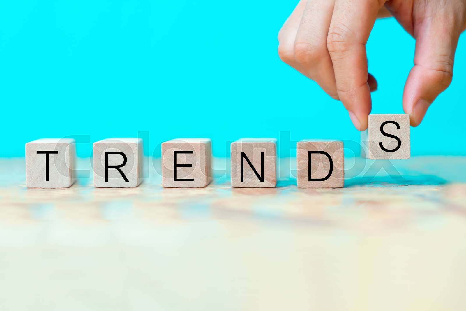 Word trends on wooden blocks with hand | Stock image | Colourbox