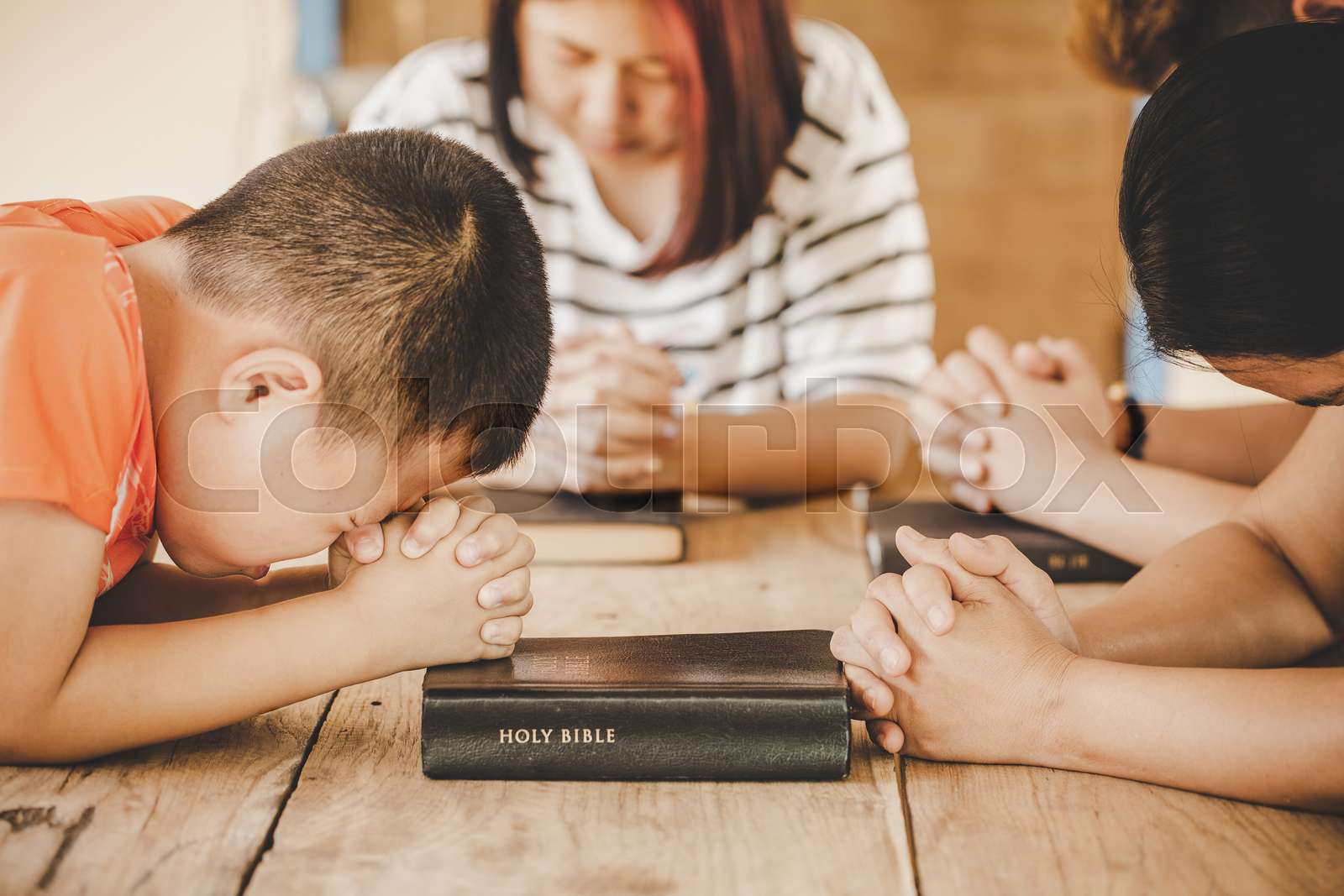 Christian family worship God in home | Stock image | Colourbox