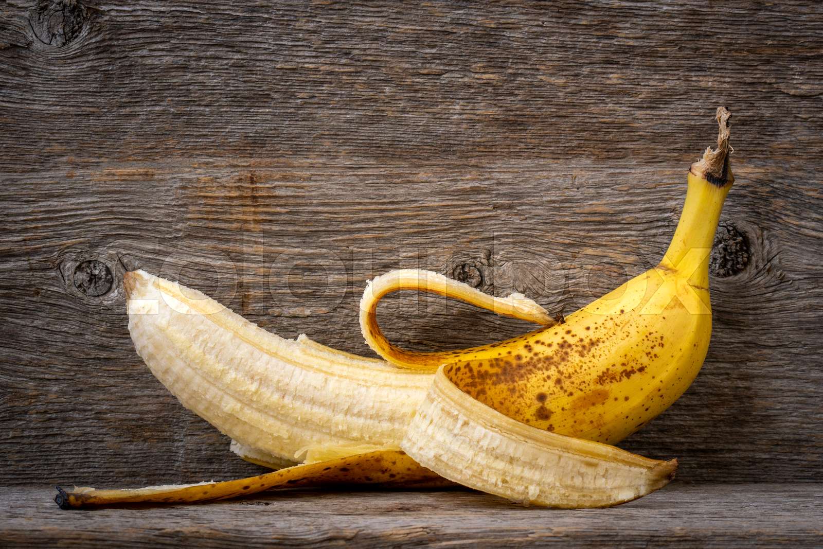 Half peeled ripe banana | Stock image | Colourbox