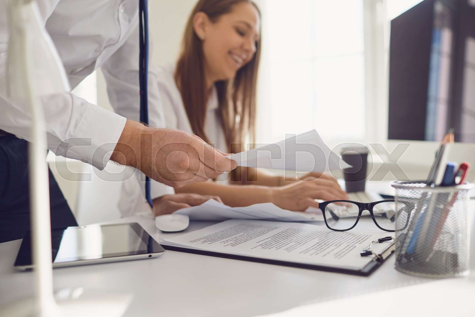 Faceless.Businessman and businesswoman working confident in a white ...