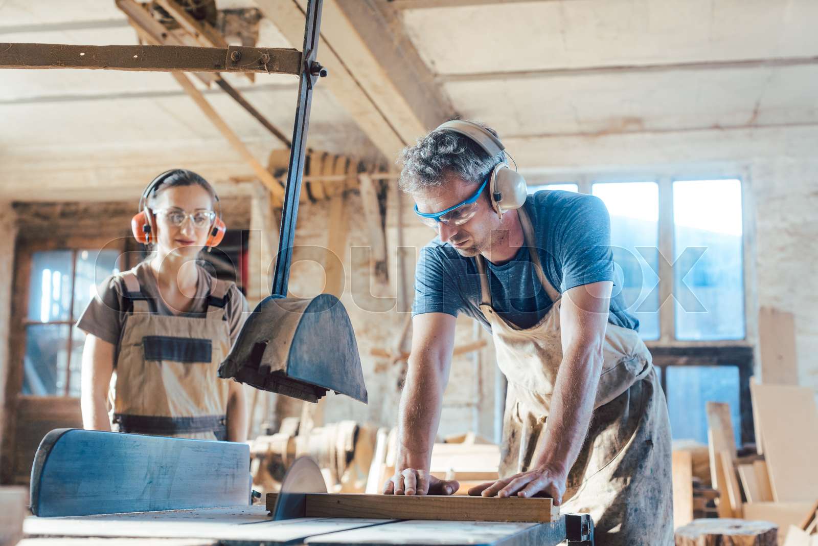 Team of carpenters working on details of a wood cut | Stock image ...