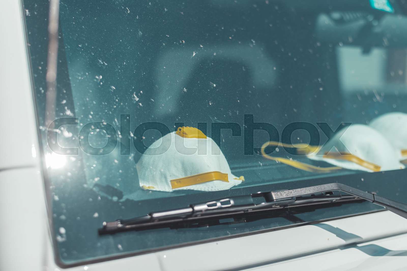 Face mask daily routine concept: Surgical mask in a car behind the ...