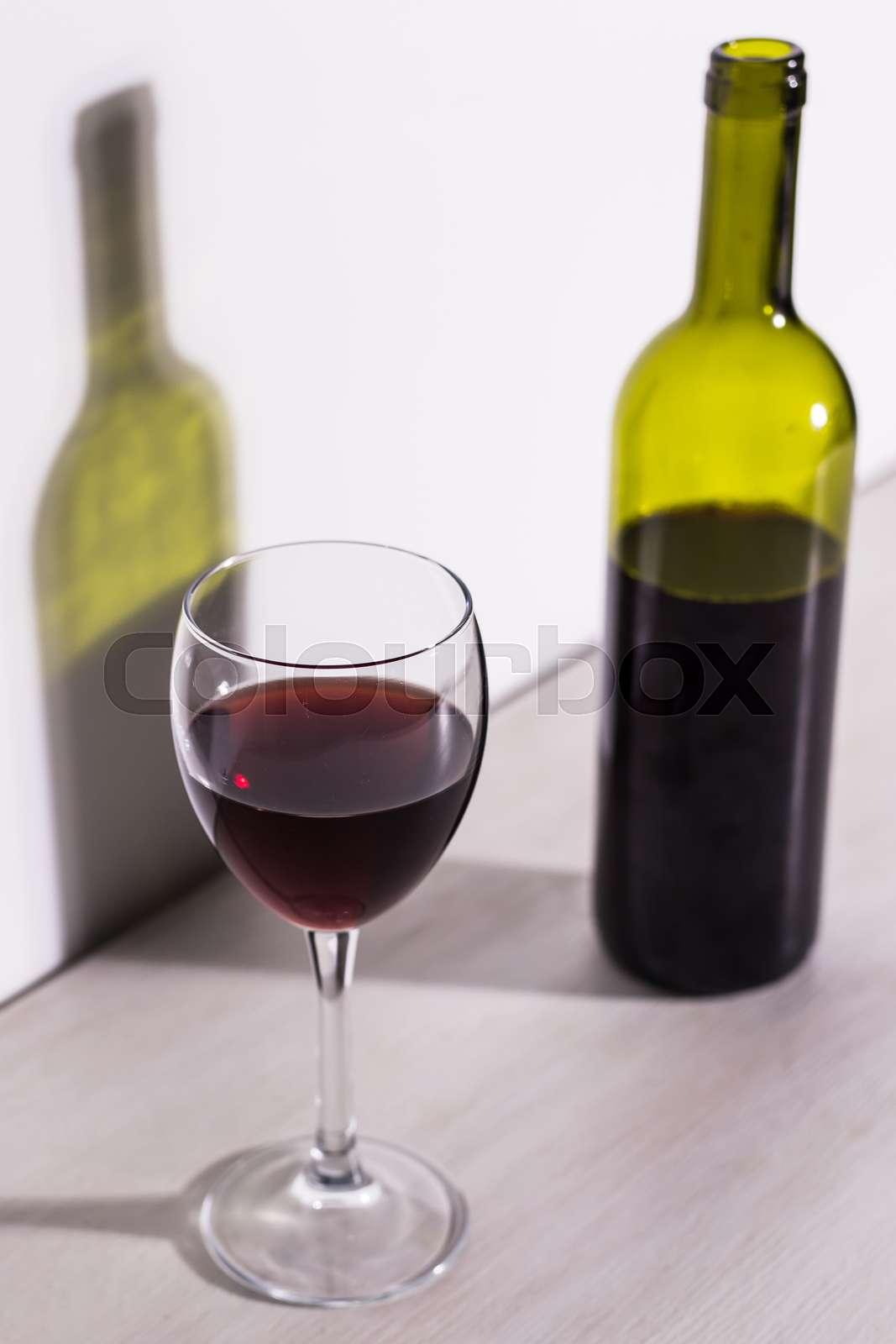 Shadow of wine glass in dark light. | Stock image | Colourbox