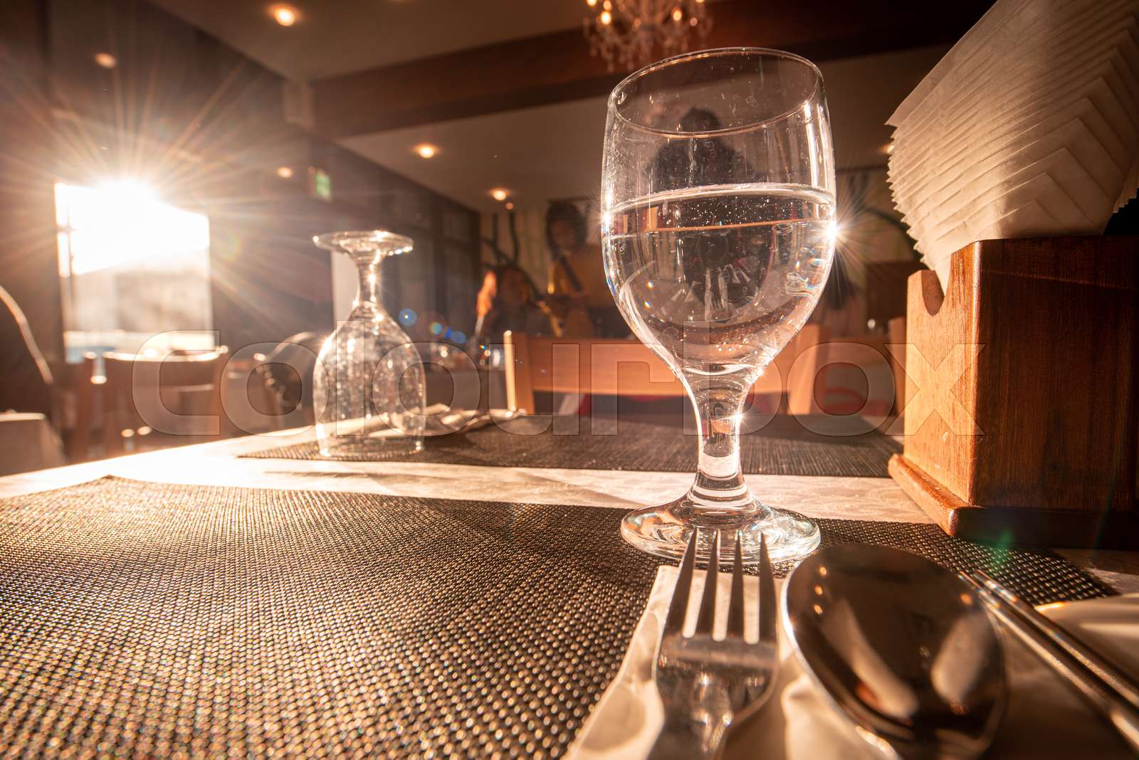 Glass of water on luxury table setting for dining. Selective focus ...