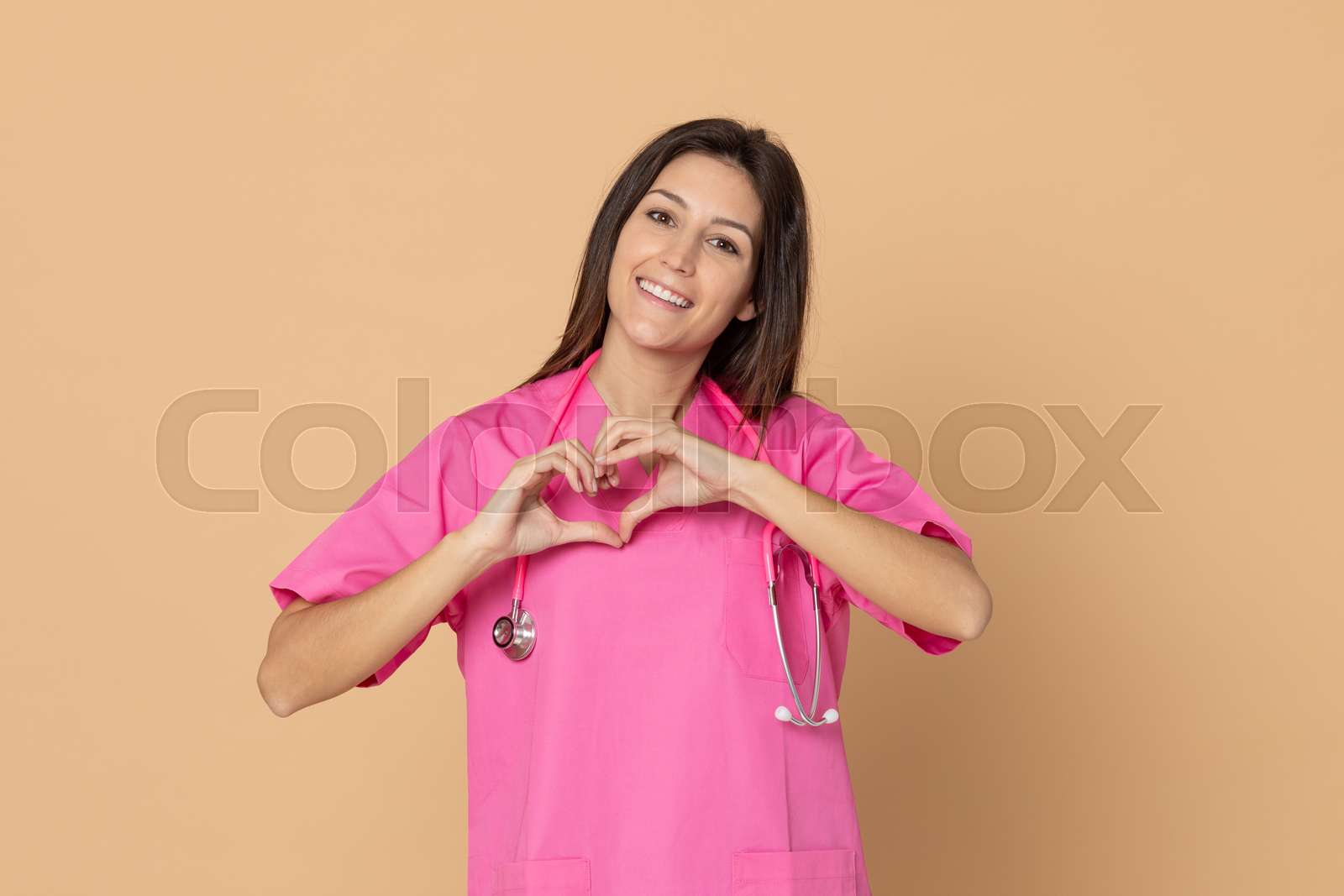 Young doctor with a pink uniform | Stock image | Colourbox
