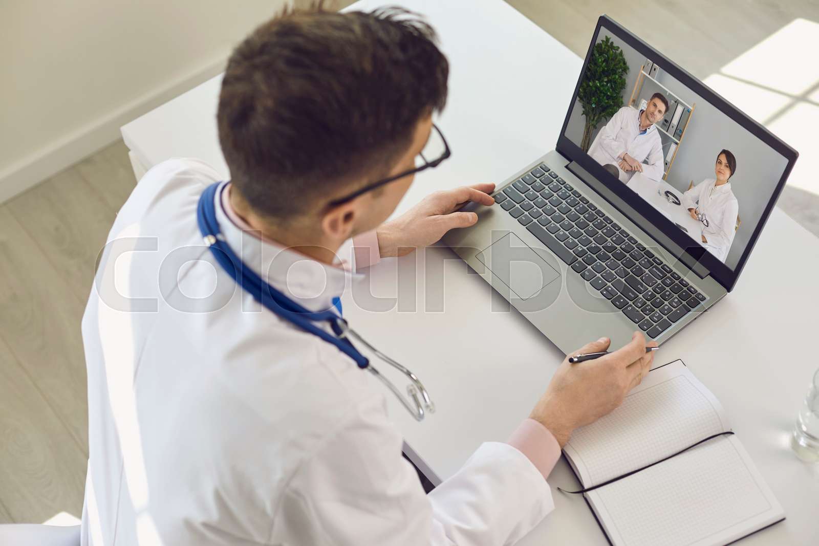Group of doctors video call conference to doctors sitting in clinic ...