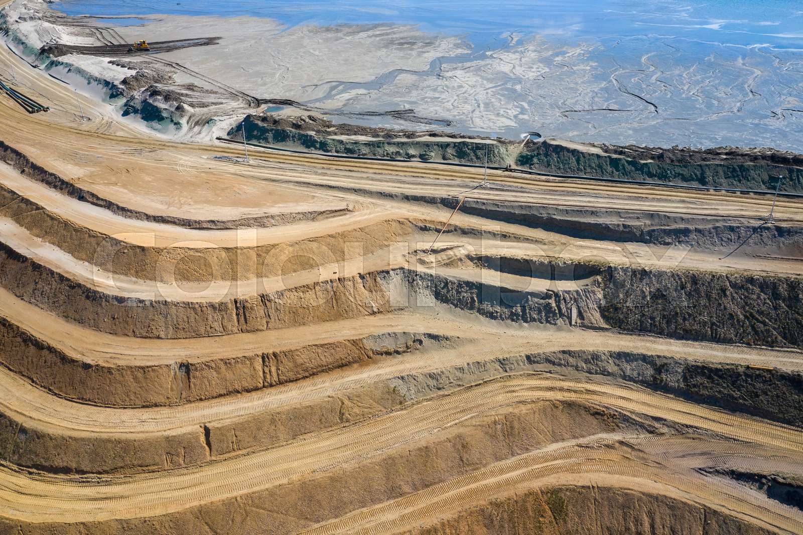 Aerial view of industrial terraces on mineral open pit mine. Opencast ...
