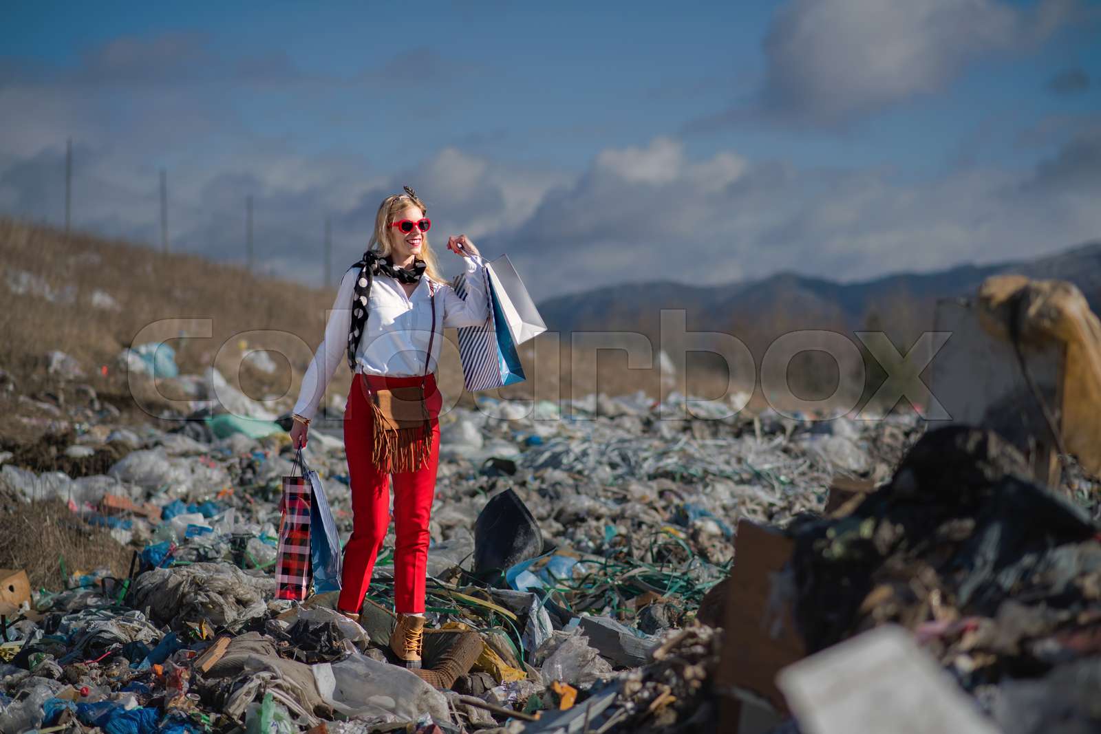 Modern woman on landfill, consumerism versus pollution concept. | Stock ...