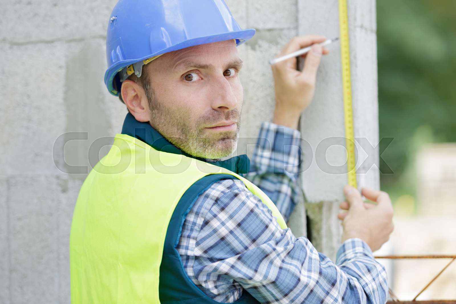 construction worker with measuring tool | Stock image | Colourbox