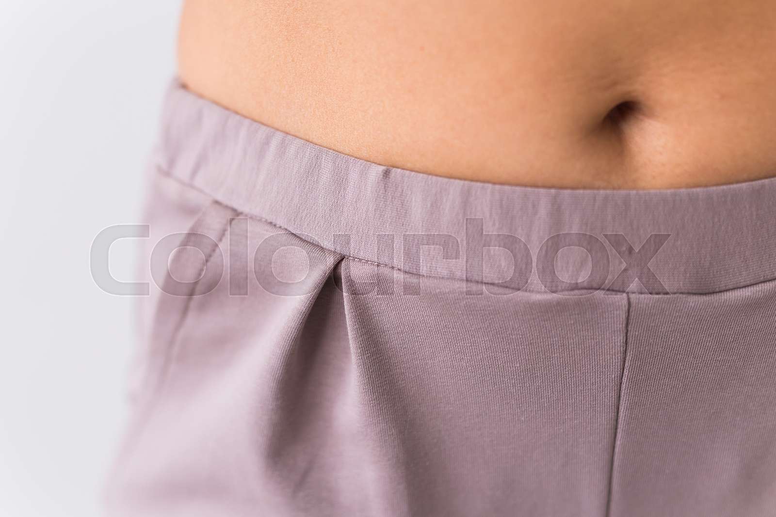 Close up photo of female slim belly with purple pants. | Stock image ...