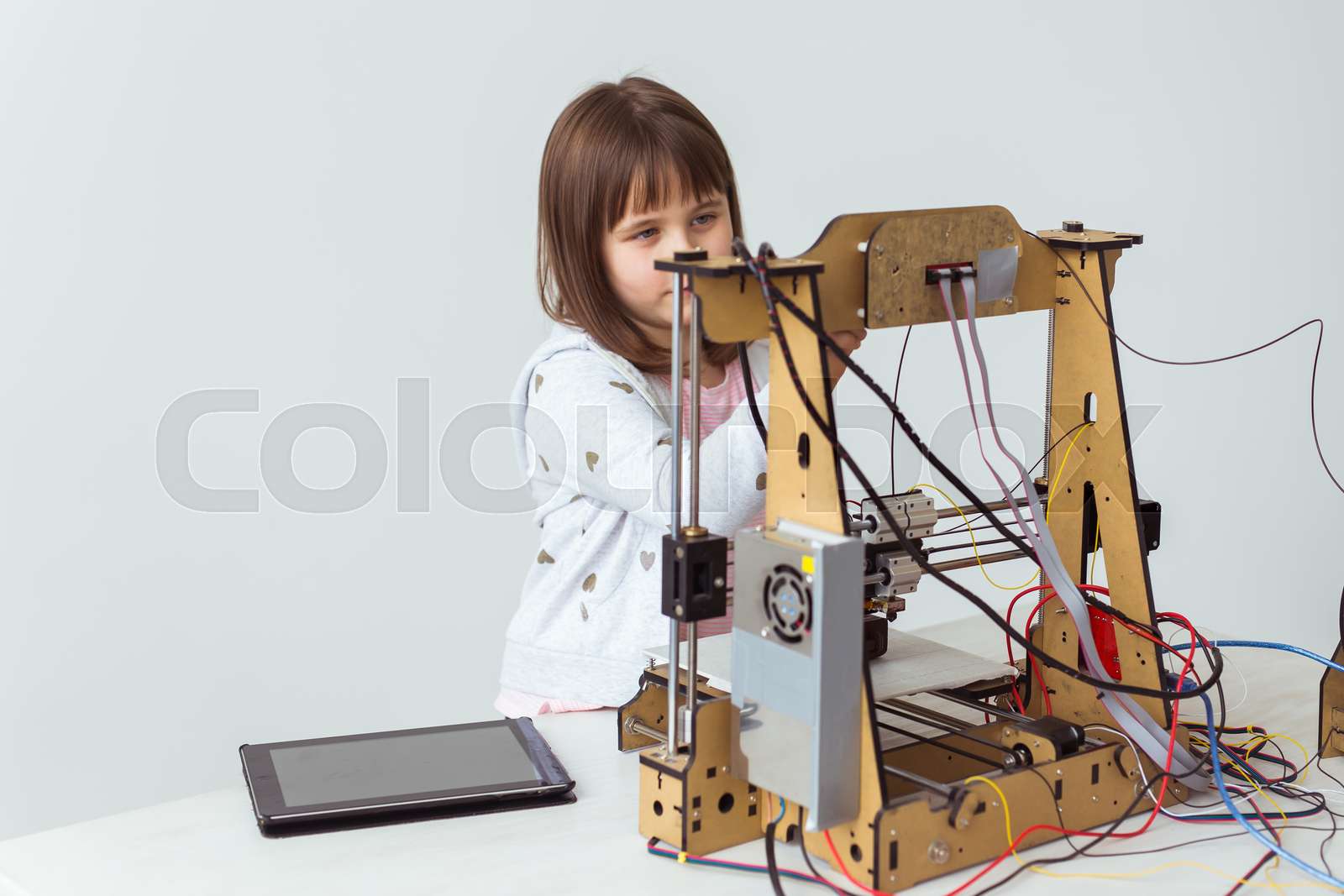 Little child architect using 3D Printer. Schoolgirl, technologies and ...