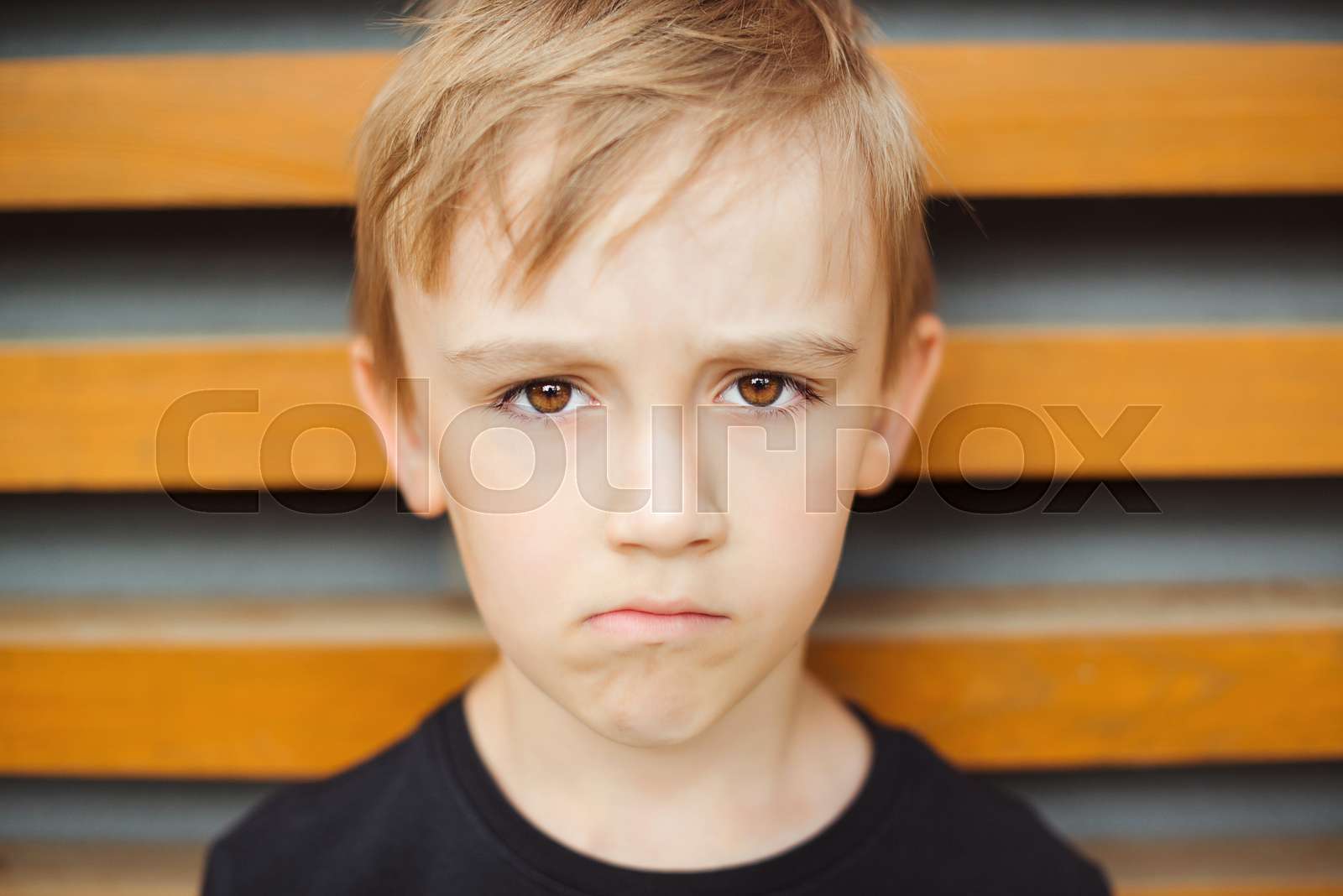 Kid having grumpy dissatisfied facial expression. Child being grounded ...
