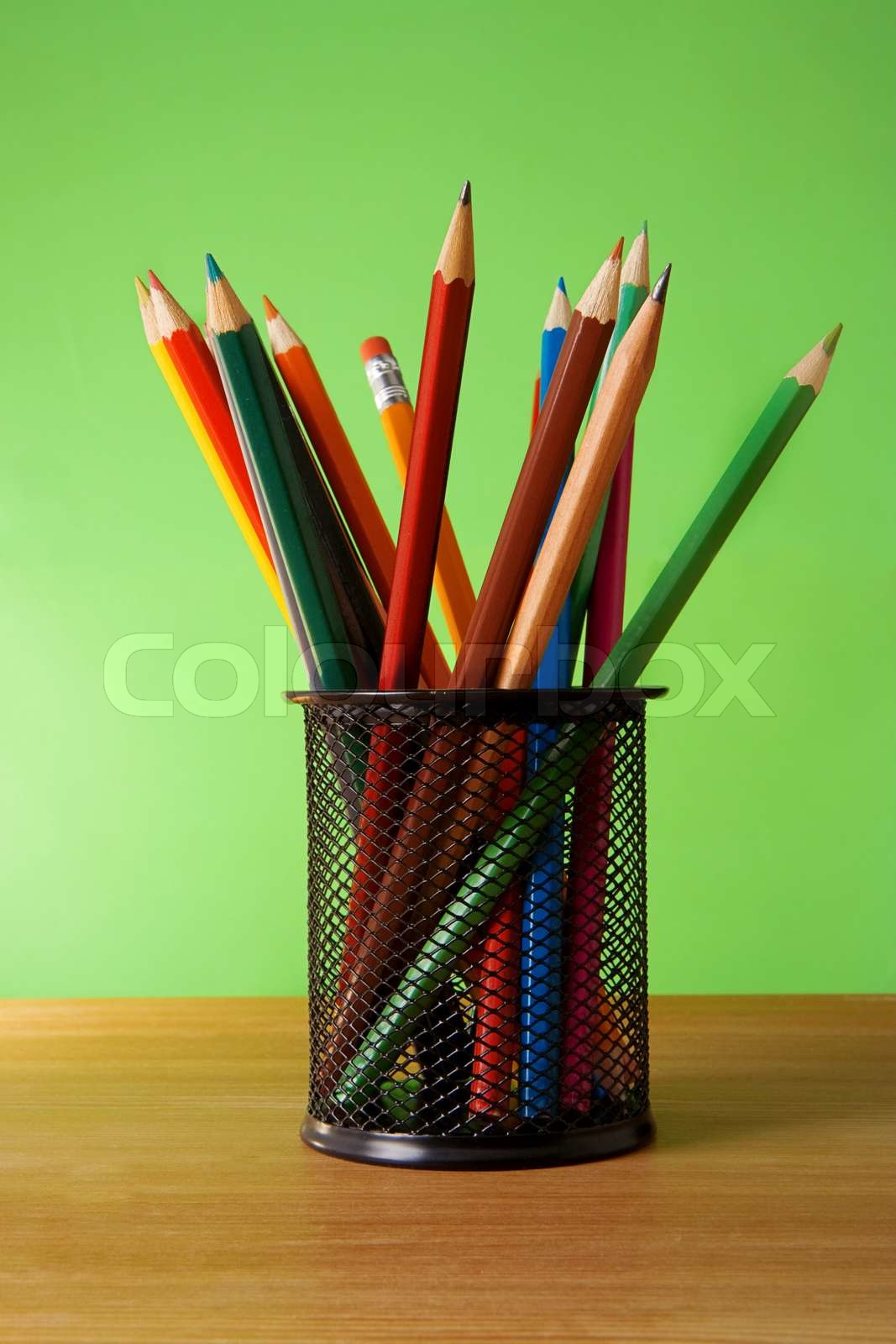 holder basket full of colored pencils on table | Stock image | Colourbox