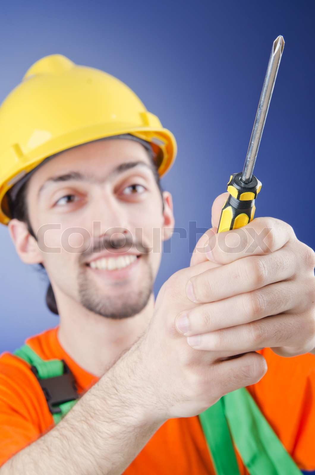 Man with a screwdriver in studio | Stock image | Colourbox