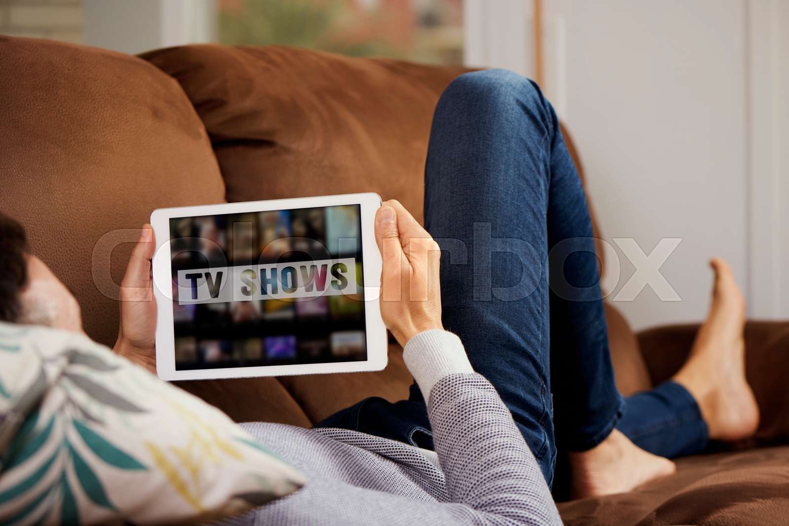 man and tablet with the text tv shows in it | Stock image | Colourbox
