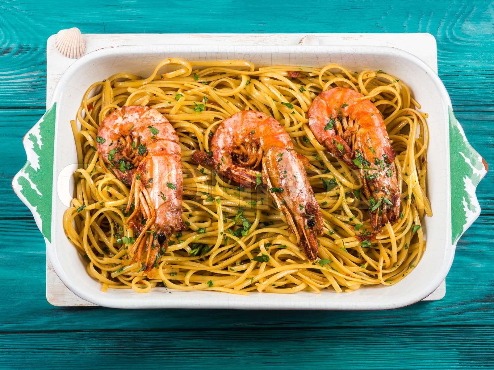 Linguine pasta with tiger prawn sauce in white dish | Stock image ...