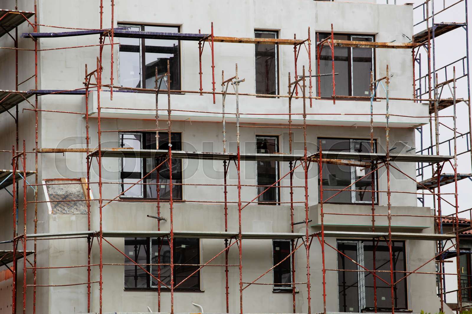 The process of renovating a new building. New construction, exterior ...