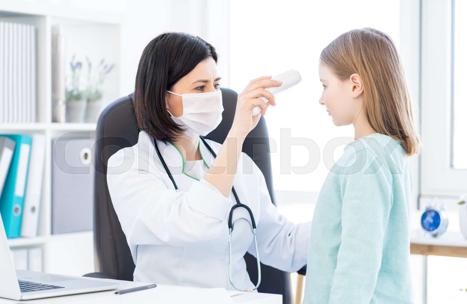 Measuring temperature in doctor's office | Stock image | Colourbox