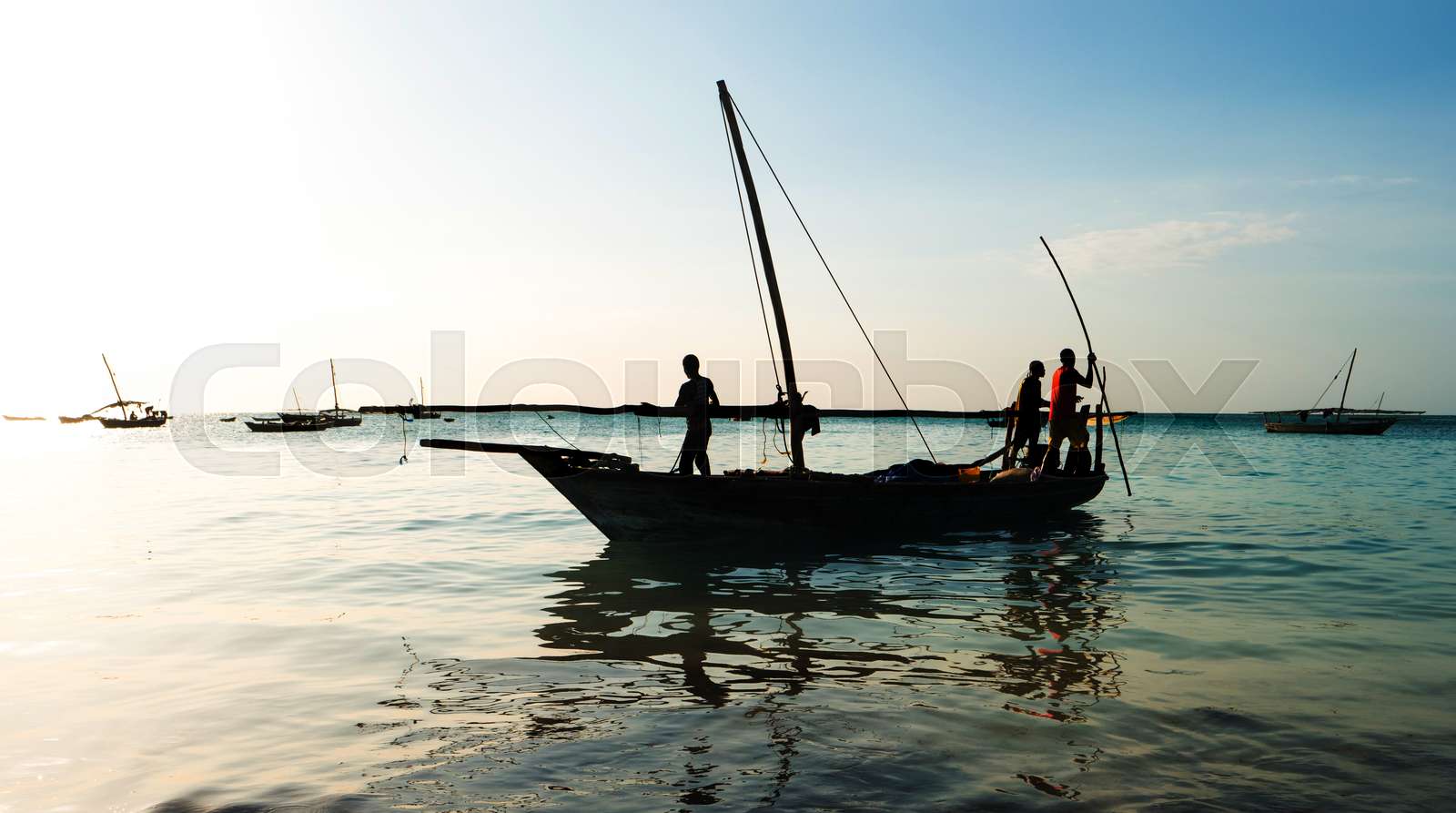 african villagers going fishing on wooden boat | Stock image | Colourbox