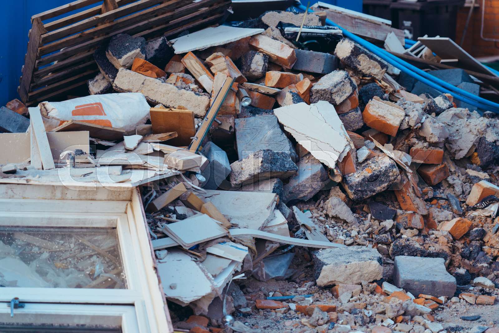 A pile of construction waste near private house. Building rubble ...