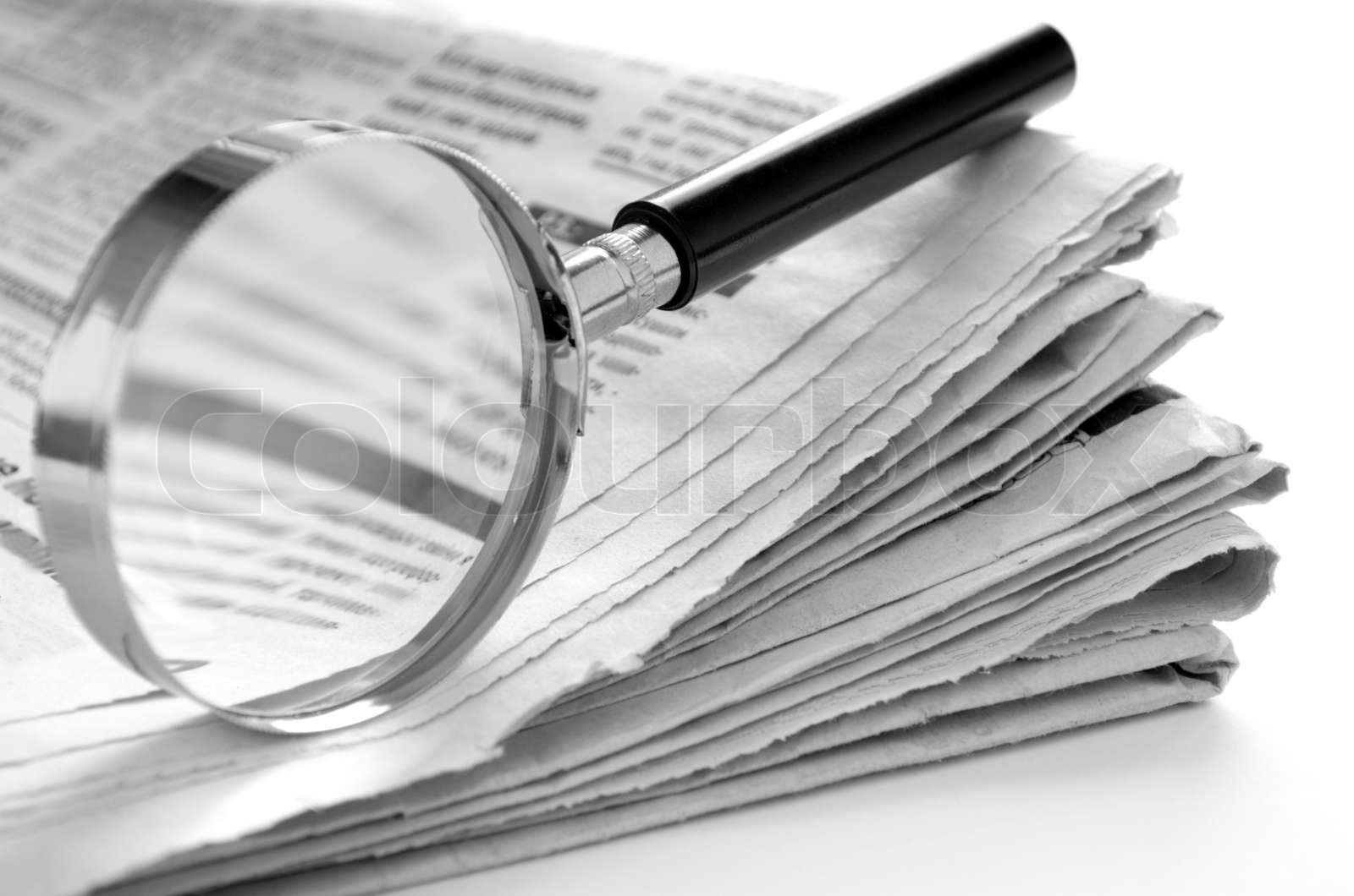 newspaper and a magnifying glass | Stock image | Colourbox