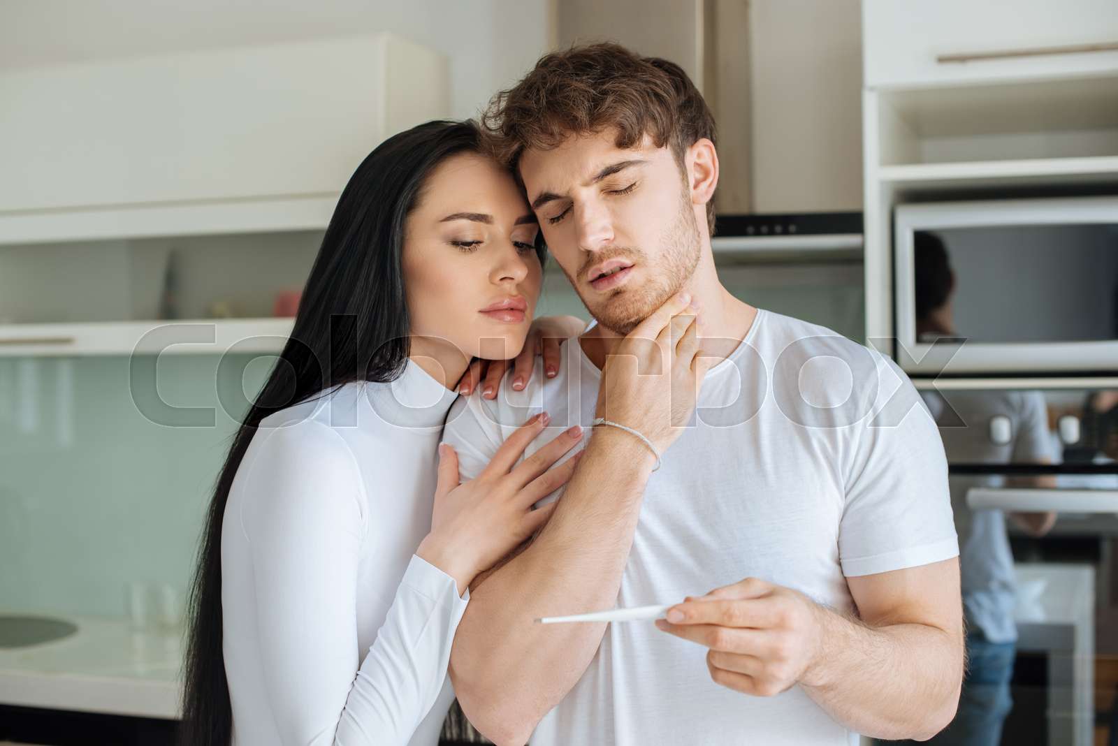 Worried girl hugging boyfriend with sore throat and looking at ...