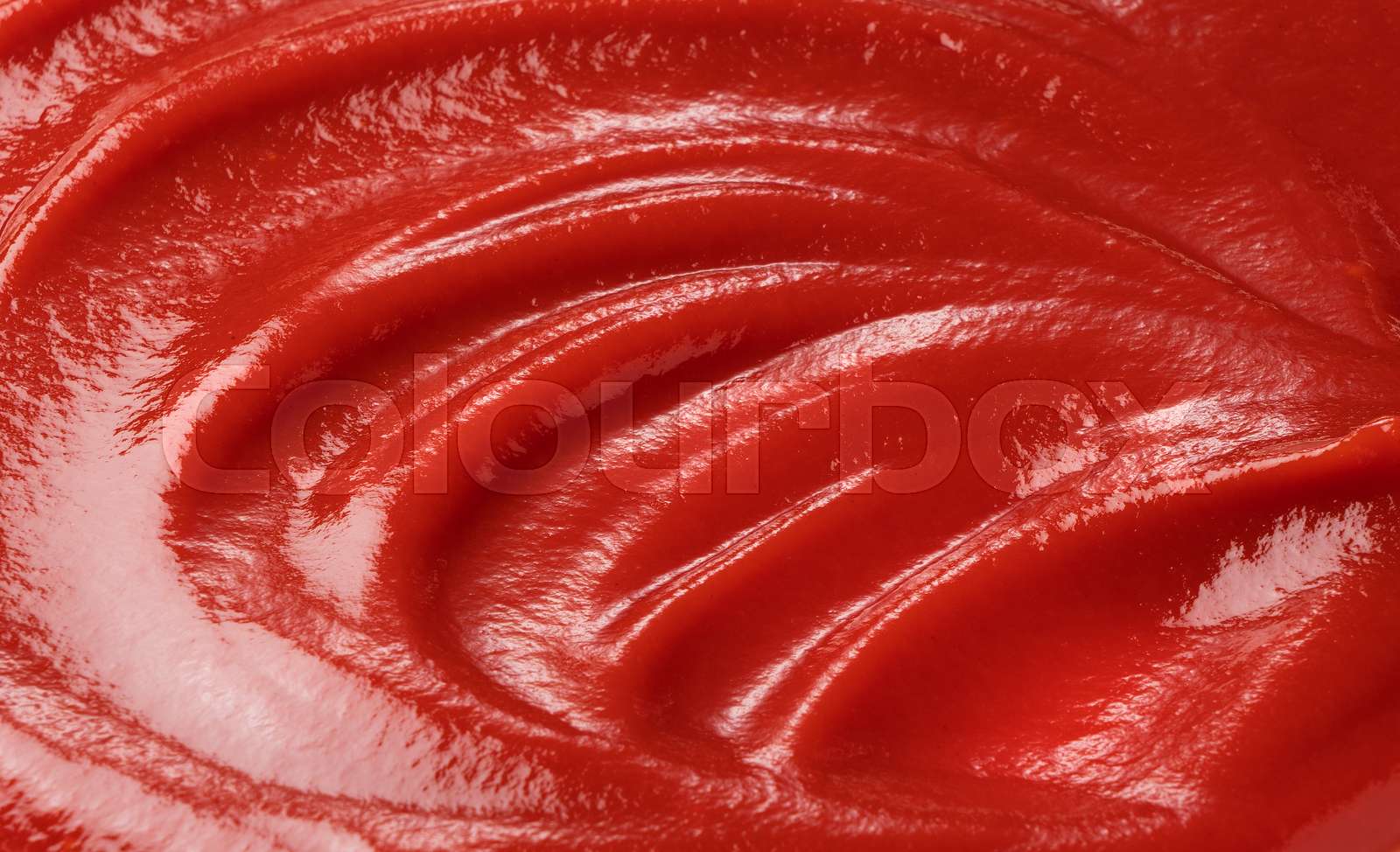 Wave of ketchup on the entire screen | Stock image | Colourbox
