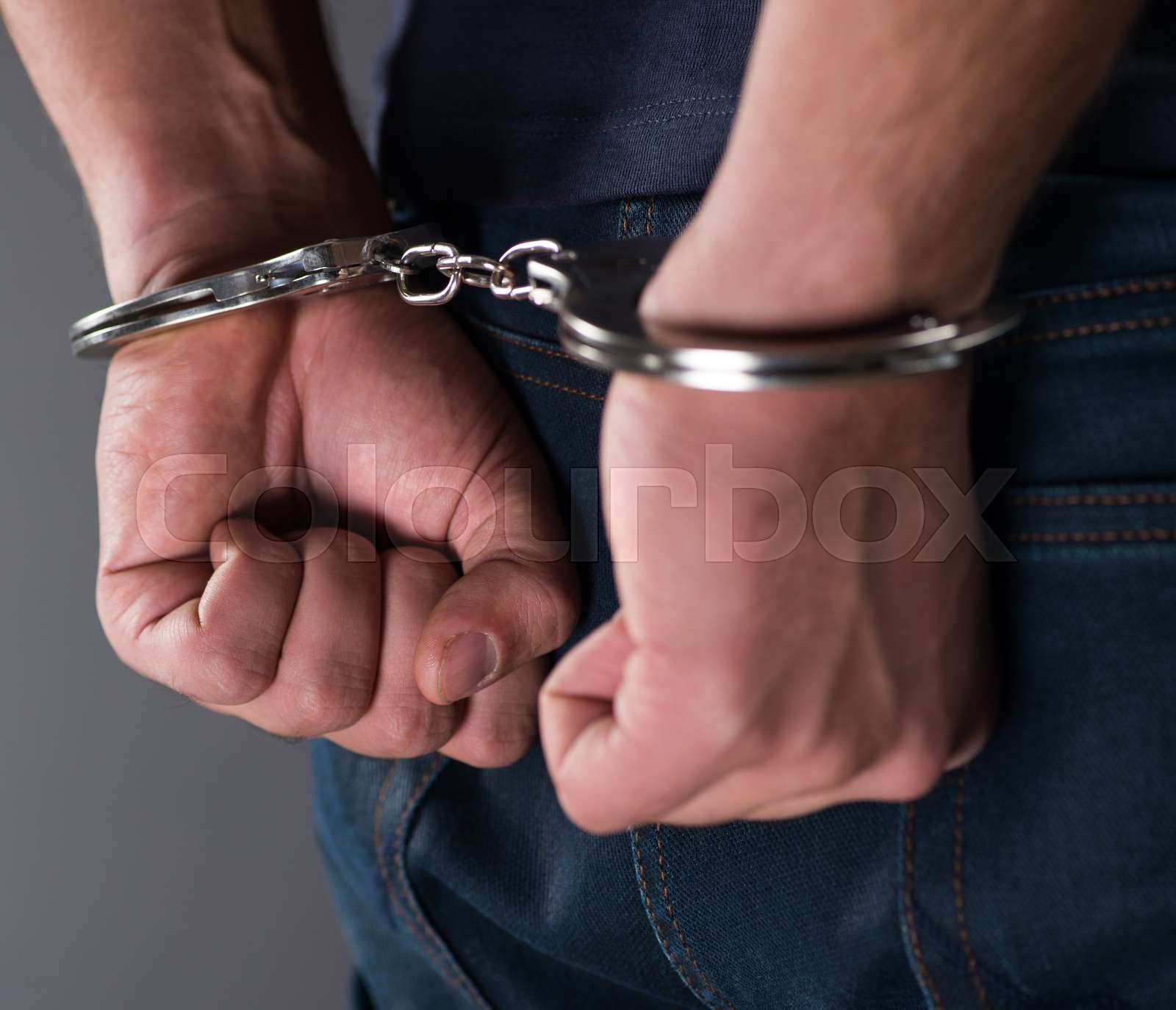 Man with his hands handcuffed in criminal concept | Stock image | Colourbox