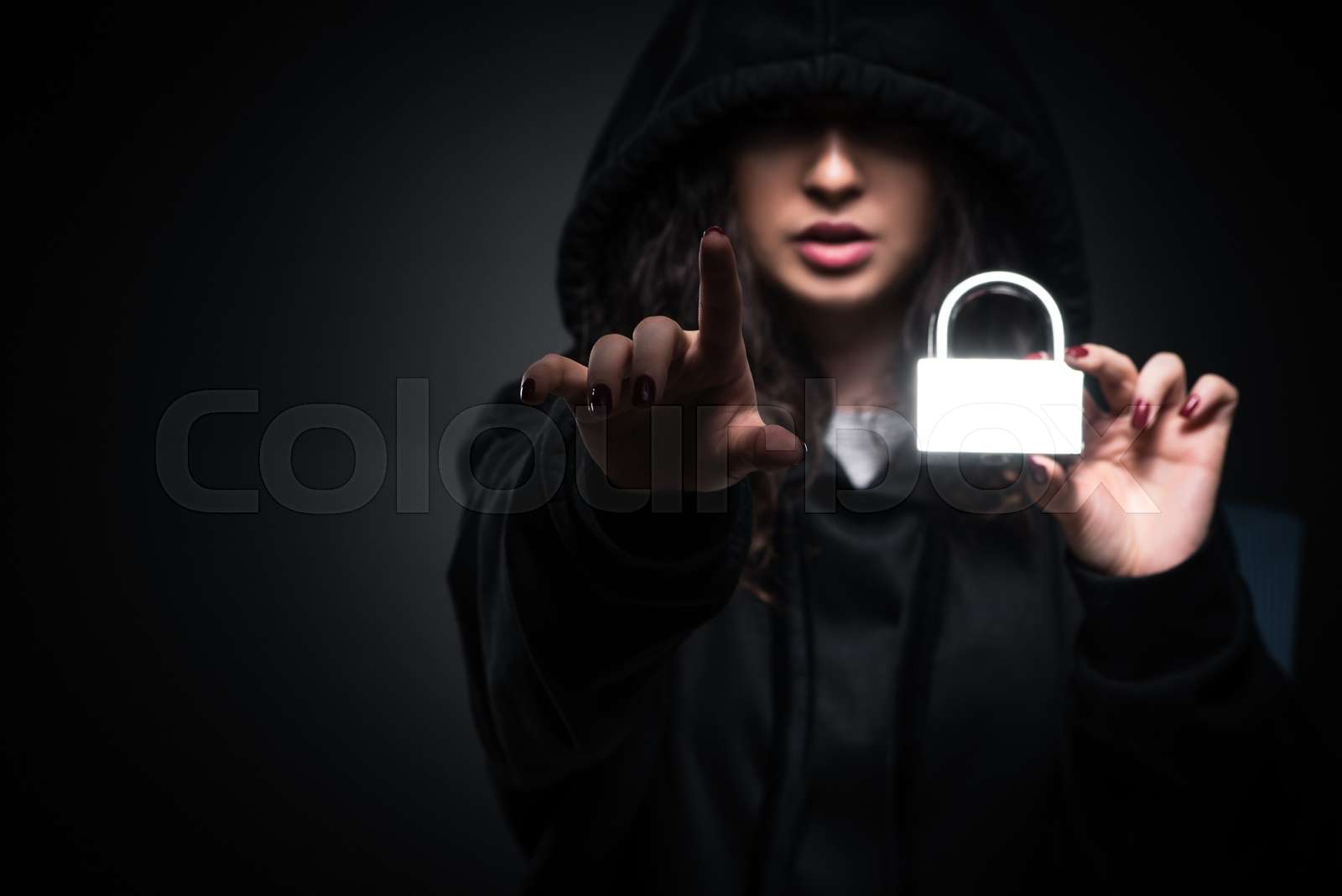 Female hacker hacking security firewall late in office | Stock image | Colourbox