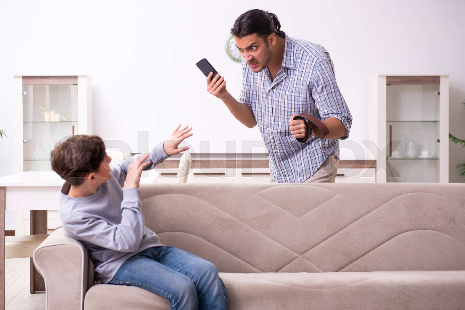 Father beating and punishing his sone | Stock image | Colourbox